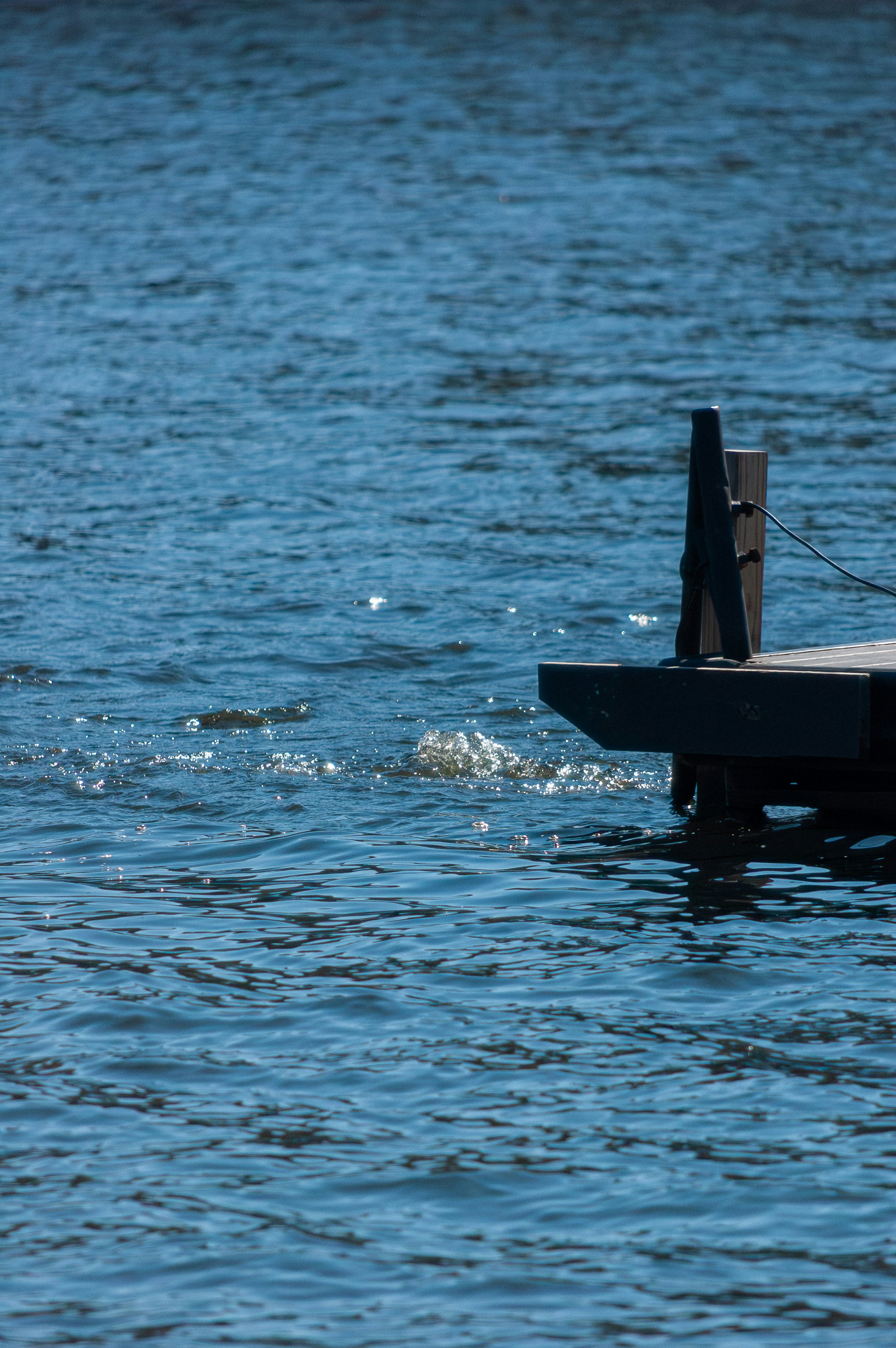 Cerulean Dock Post: Quiet Blue Ripples at Waterfront Edge