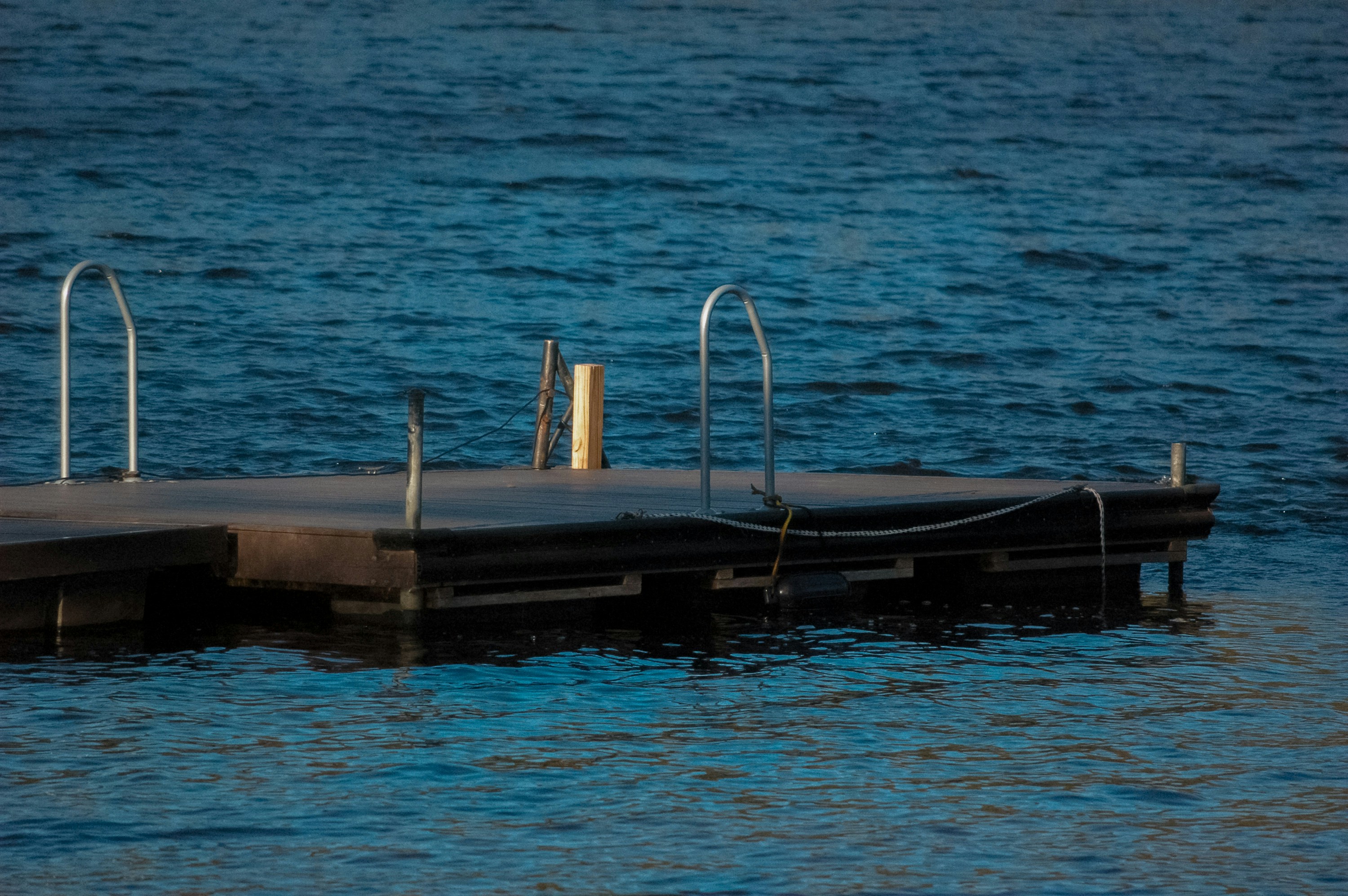 Dusk at the Dock: A Silent Pier Anchored in Deep Blue
