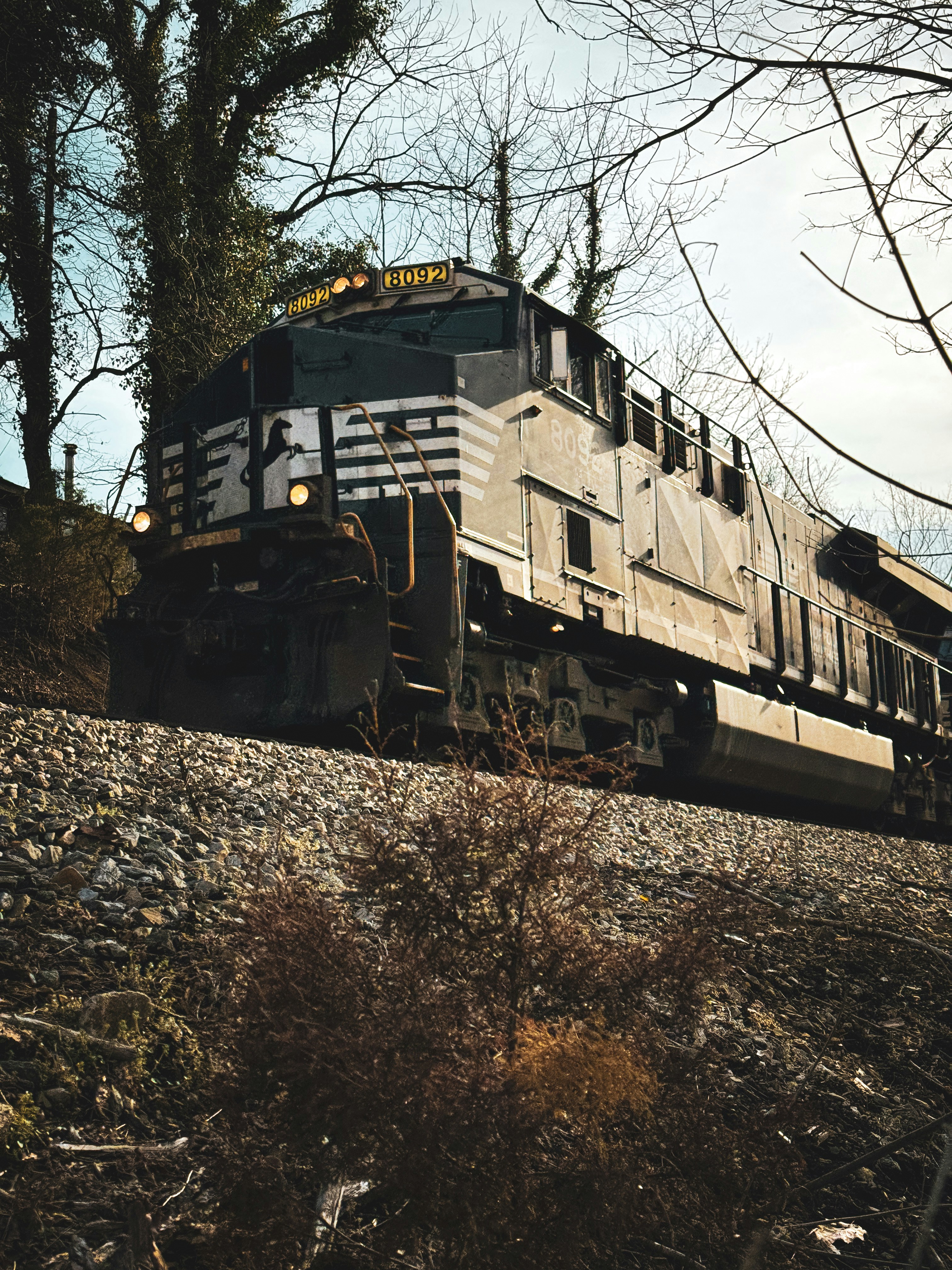 Low-Angle Freight: A Weathered Diesel Locomotive on a Gravel Embankment
