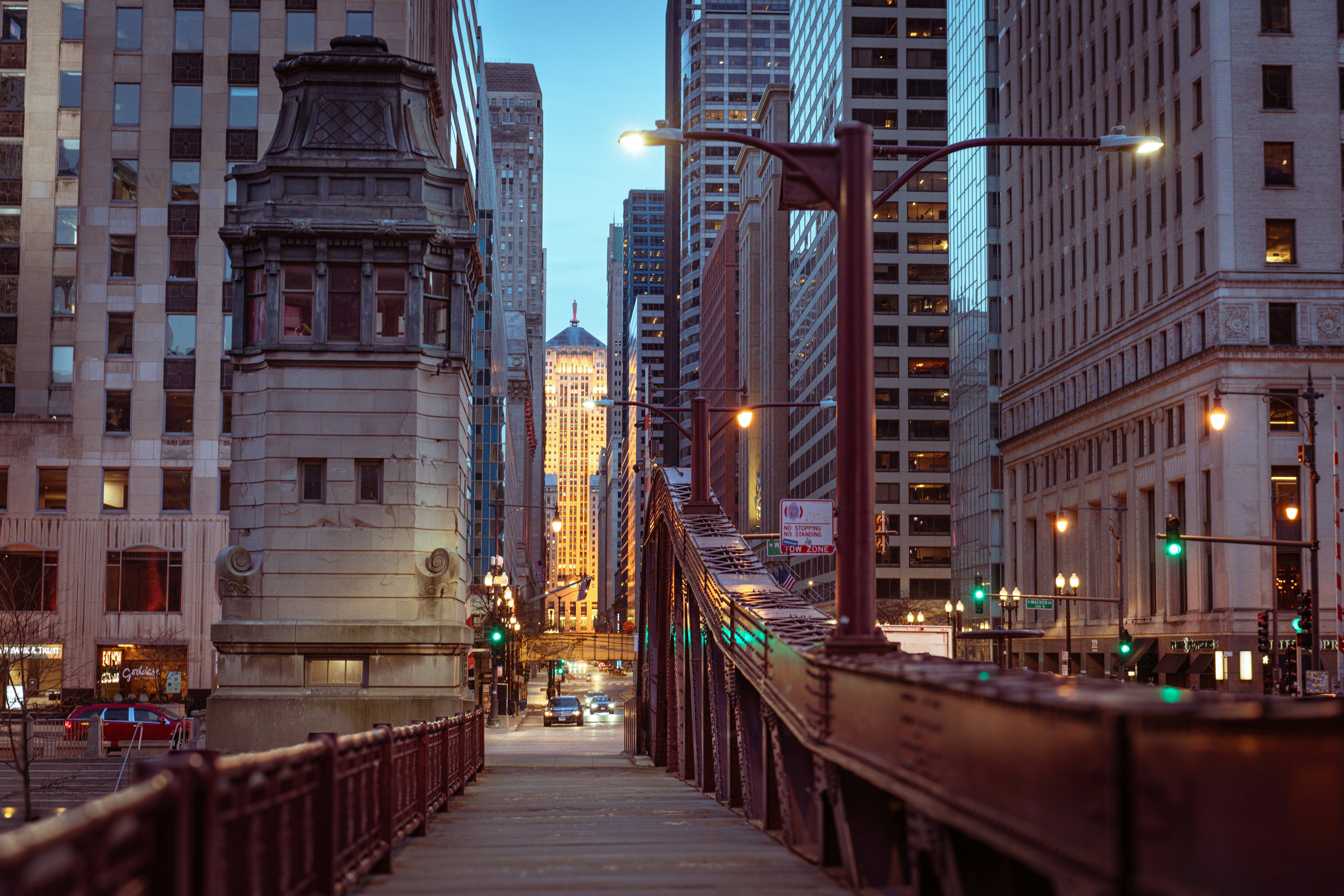 A view of a city street with a bridge in the foreground photo – Free ...