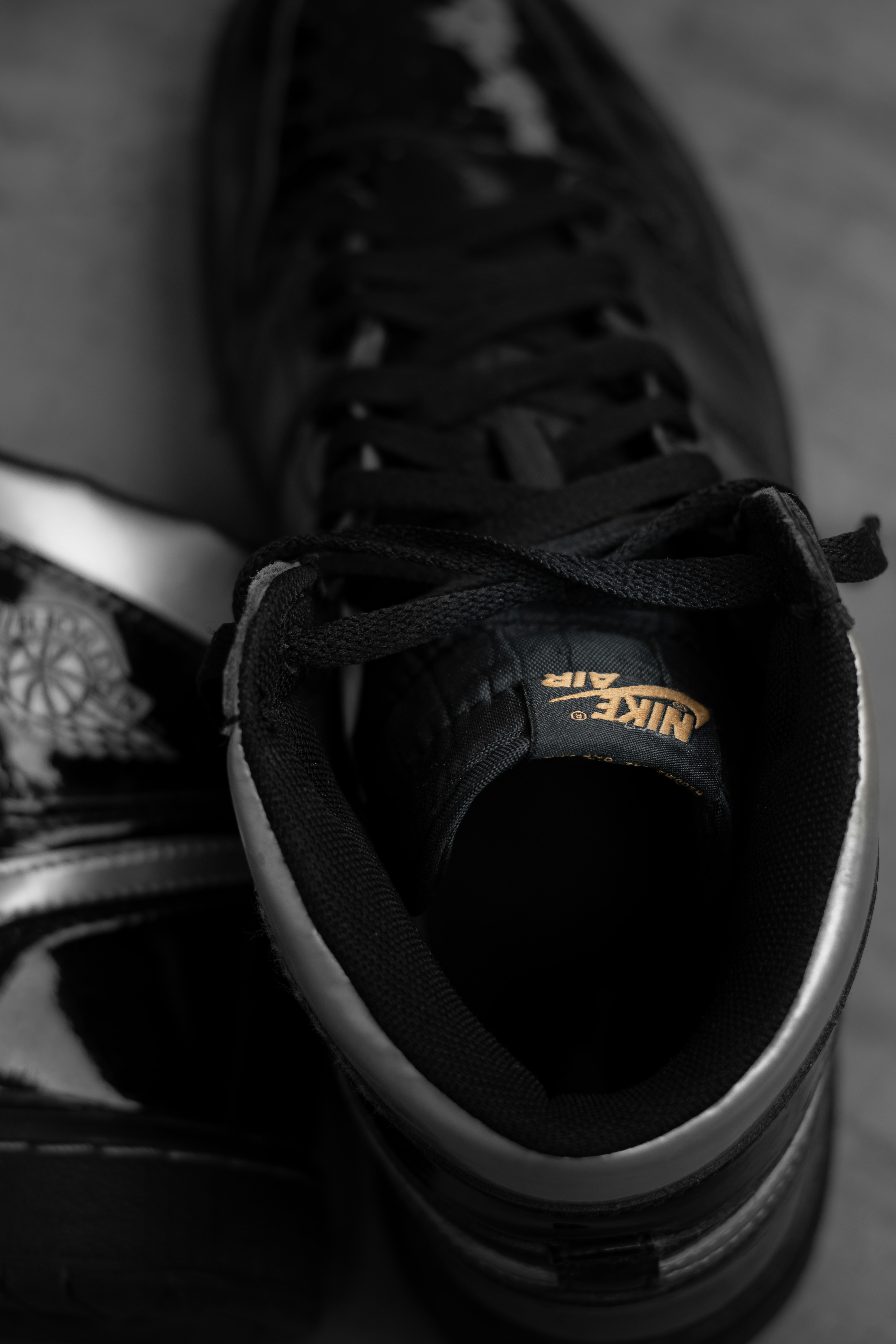 Understated Focus: Close-Up of a Black Nike Sneaker's Lacing and Logo