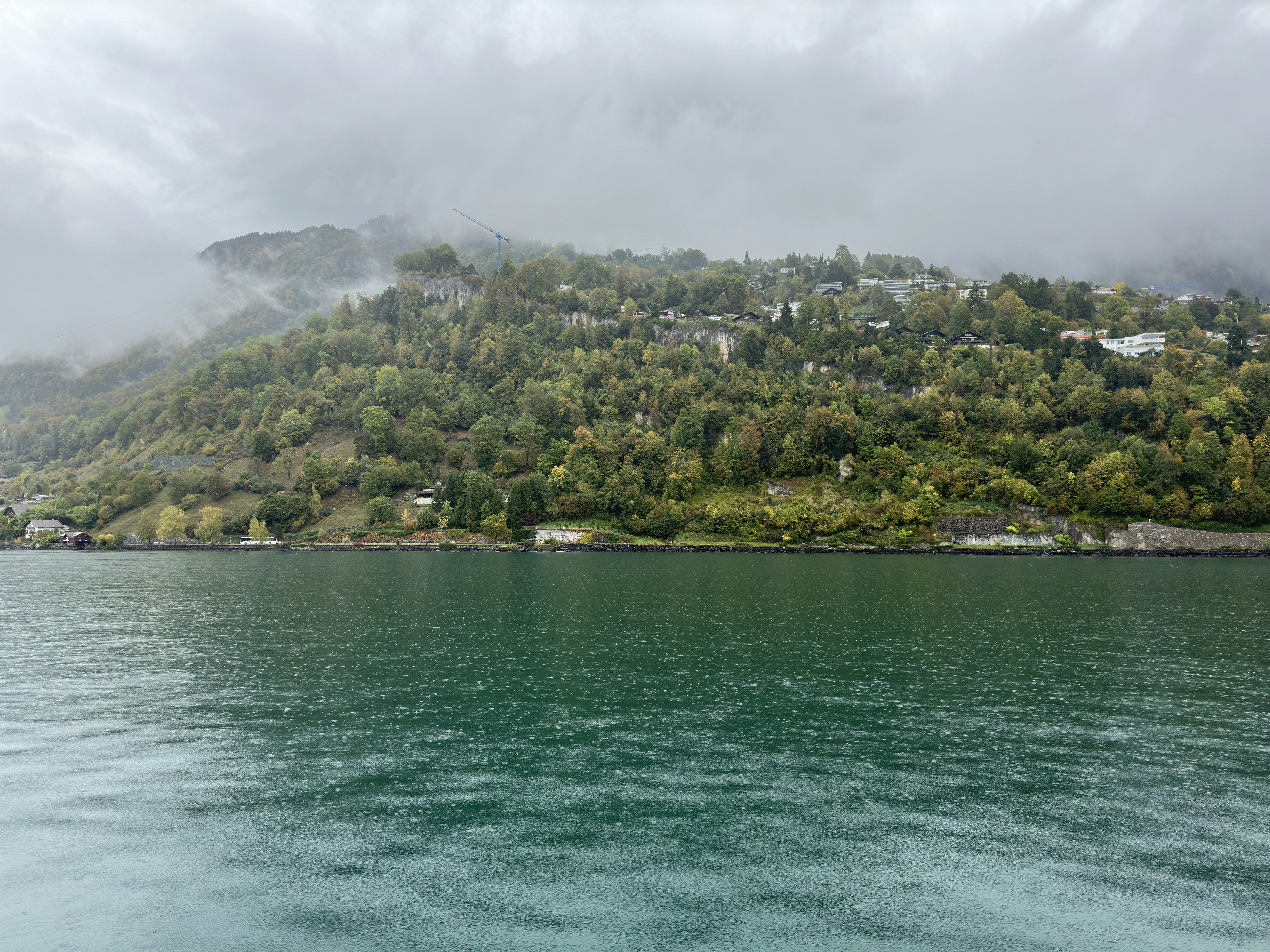 Mist-Kissed Hillside Village Above a Glassy Turquoise Lake
