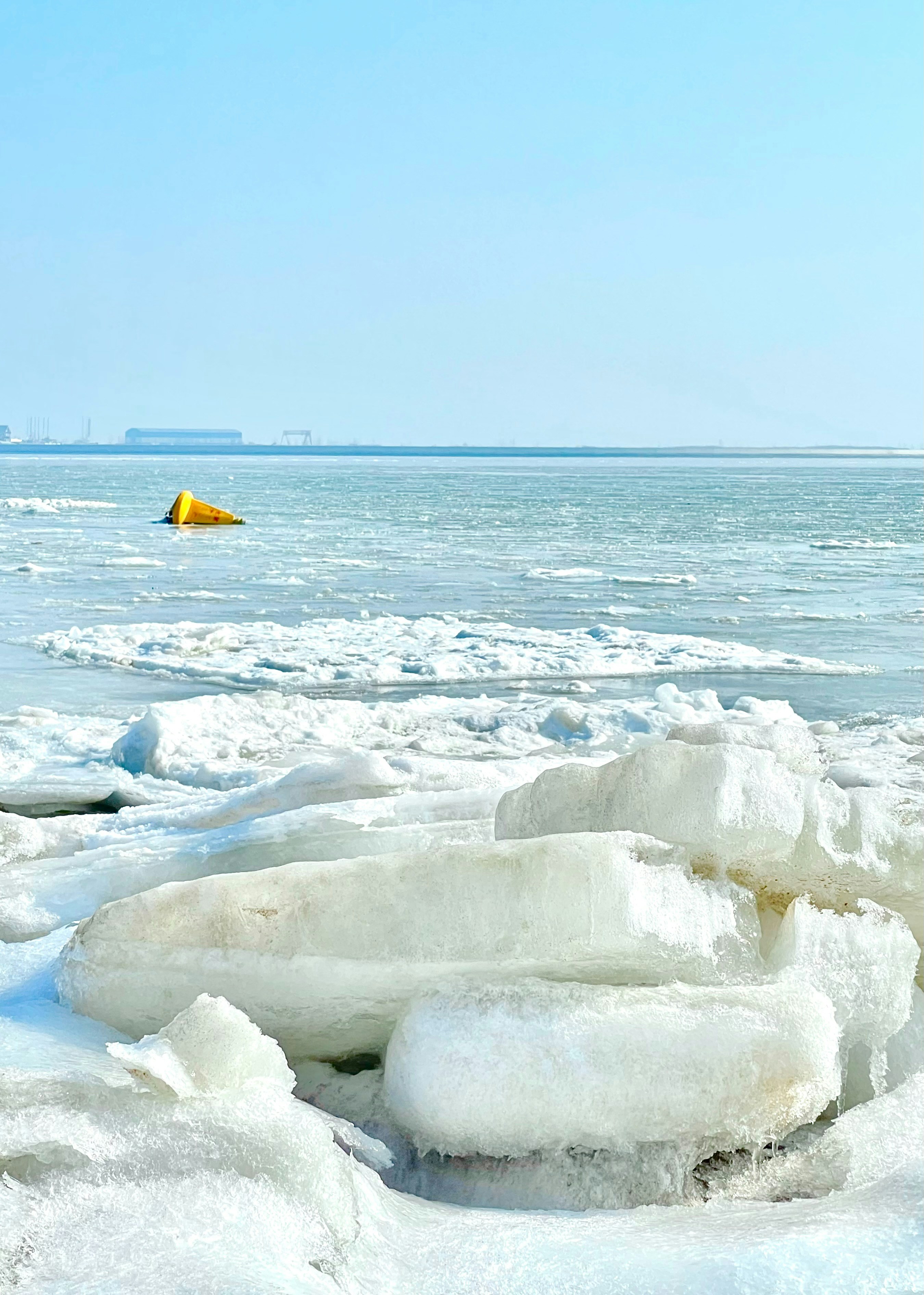 Icebound Horizon: A Quiet Seascape with a Yellow Buoy