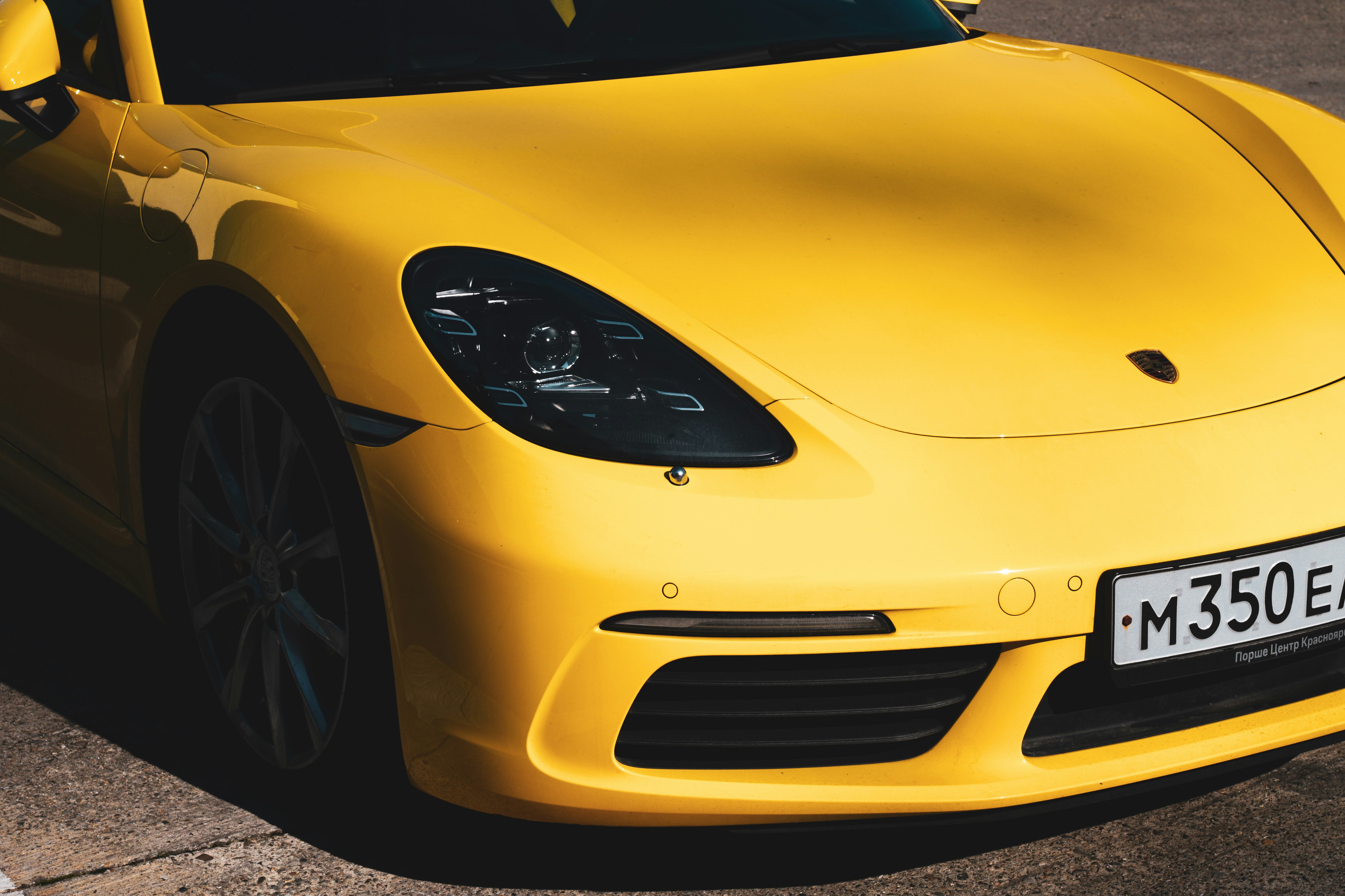 A yellow sports car parked in a parking lot photo – Free Sochi Image on ...