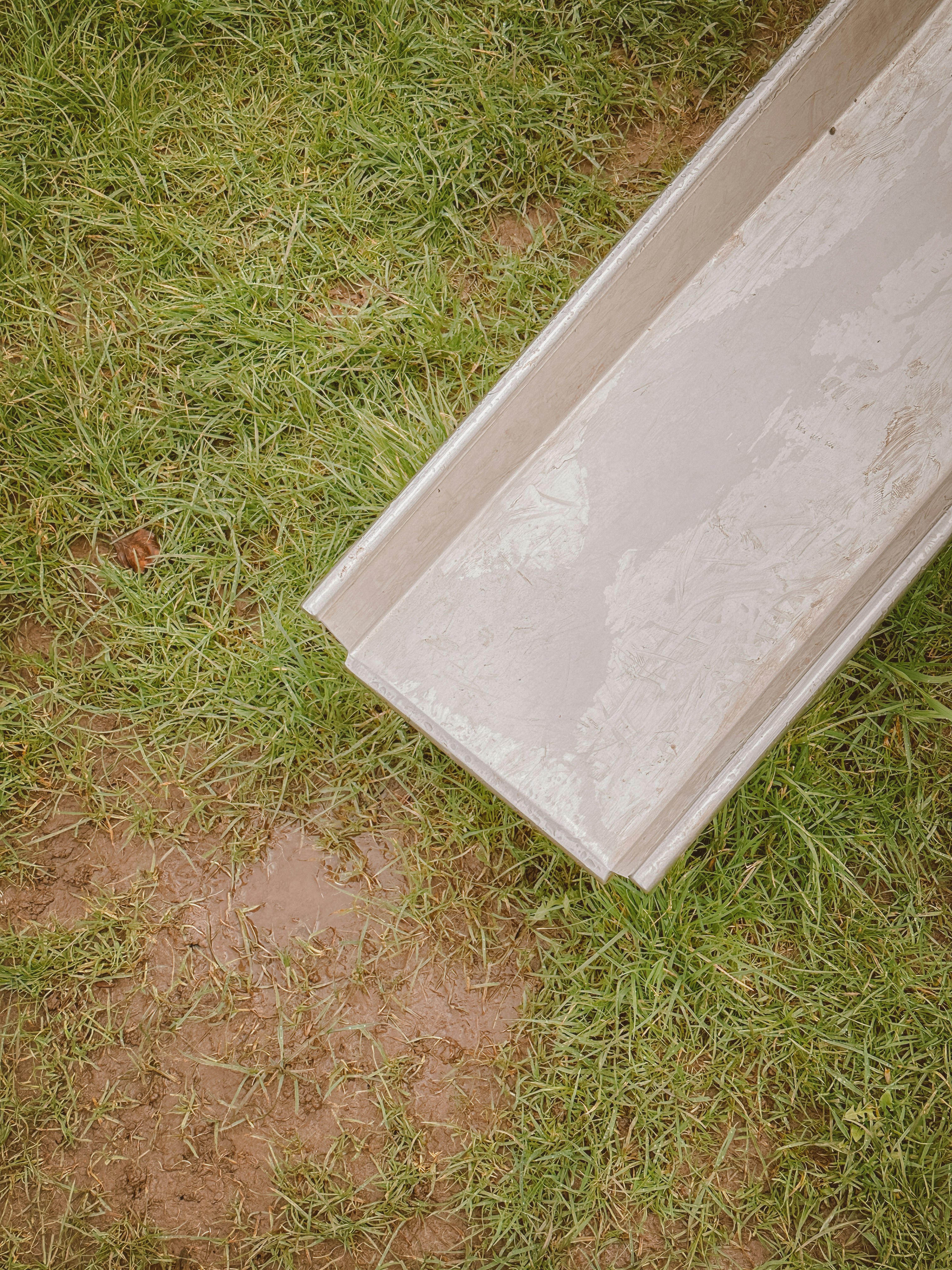 A white object laying on the ground in the grass photo – Free Ugc Image ...