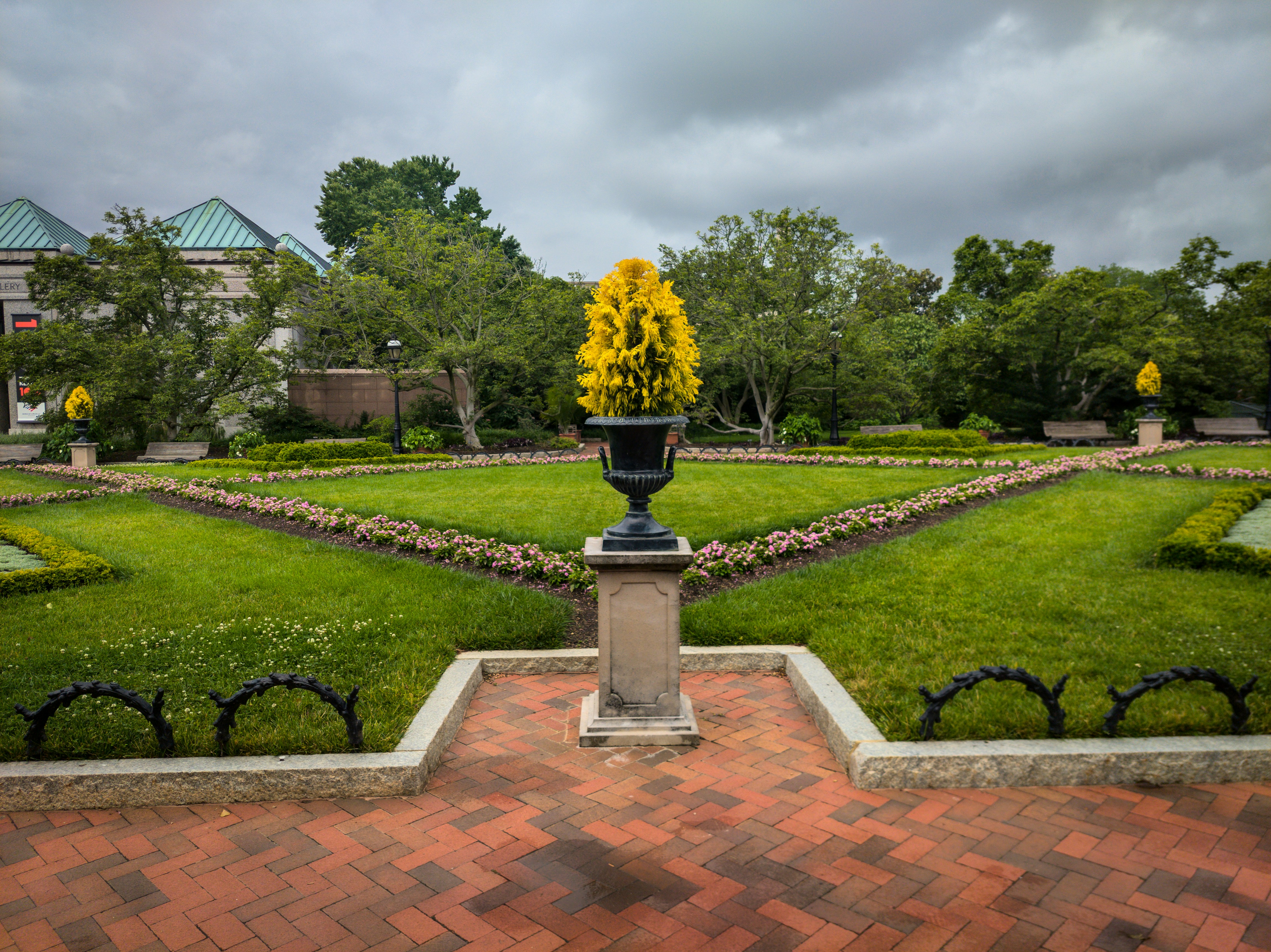 Central Yellow Urn Anchors a Formal Garden Axis