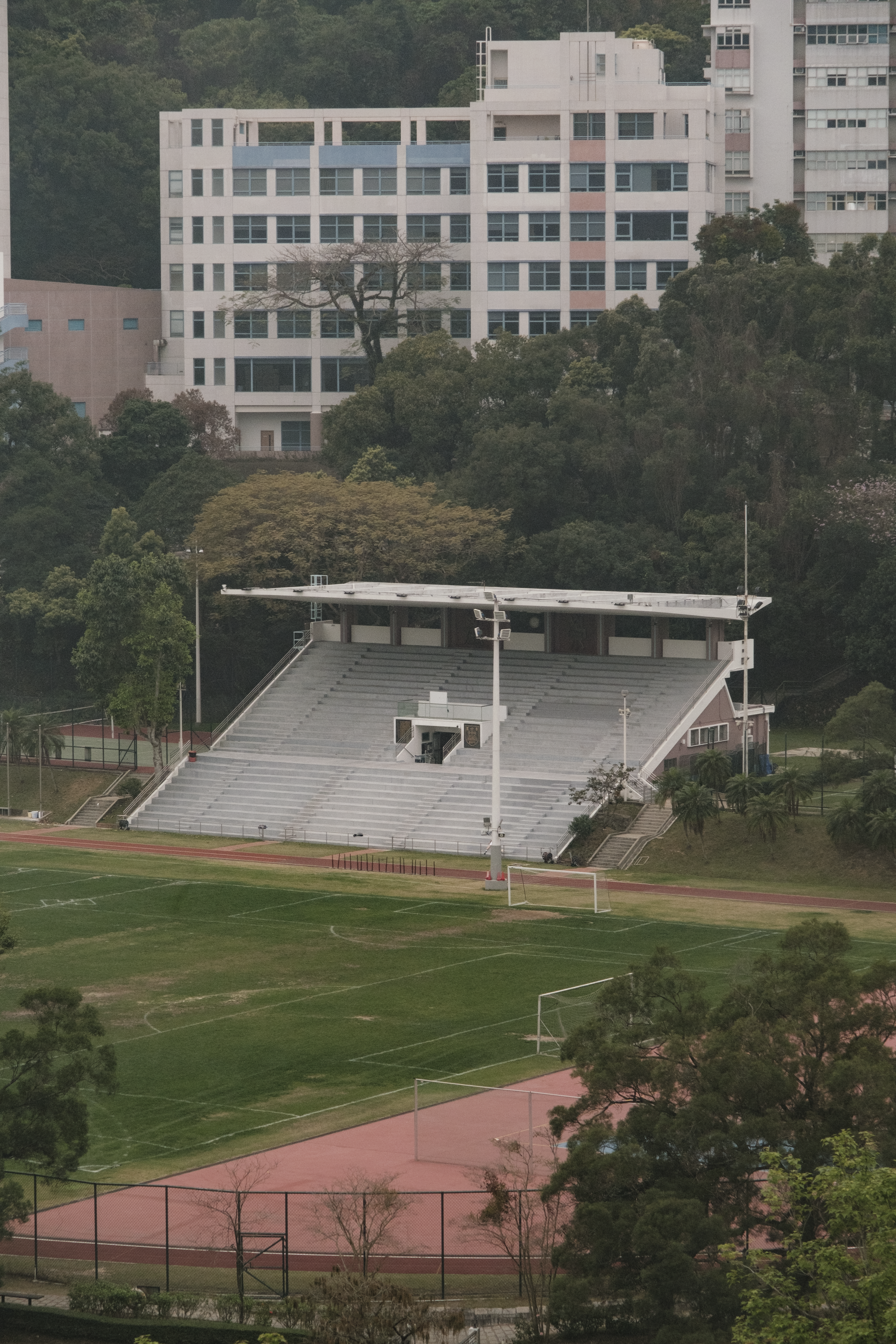 Bleachers Between Trees and Towers