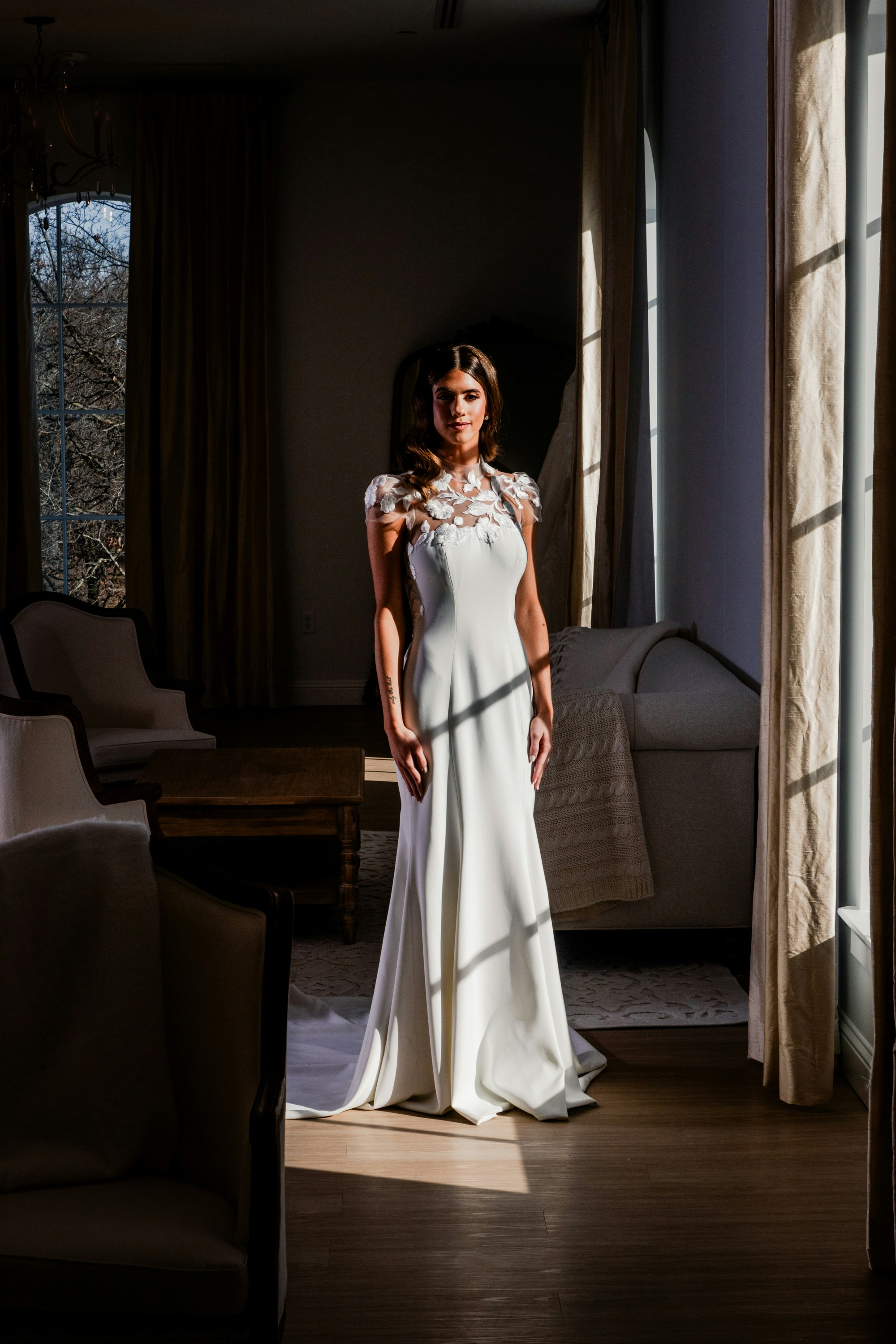 Sunlit Silhouette: A Bride Standing in Quiet Interior Light