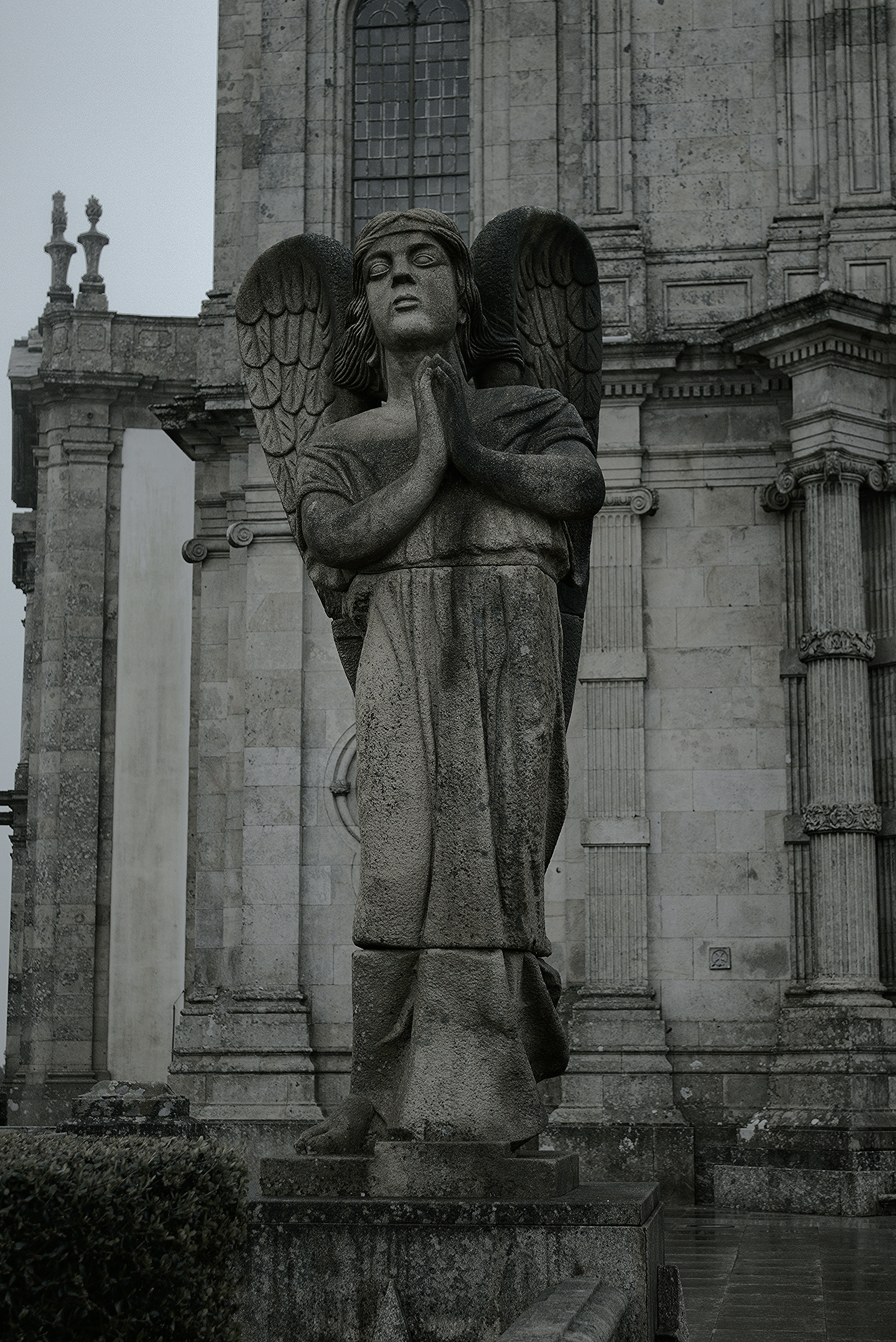 Praying Angel at the Threshold of a Weathered Cathedral