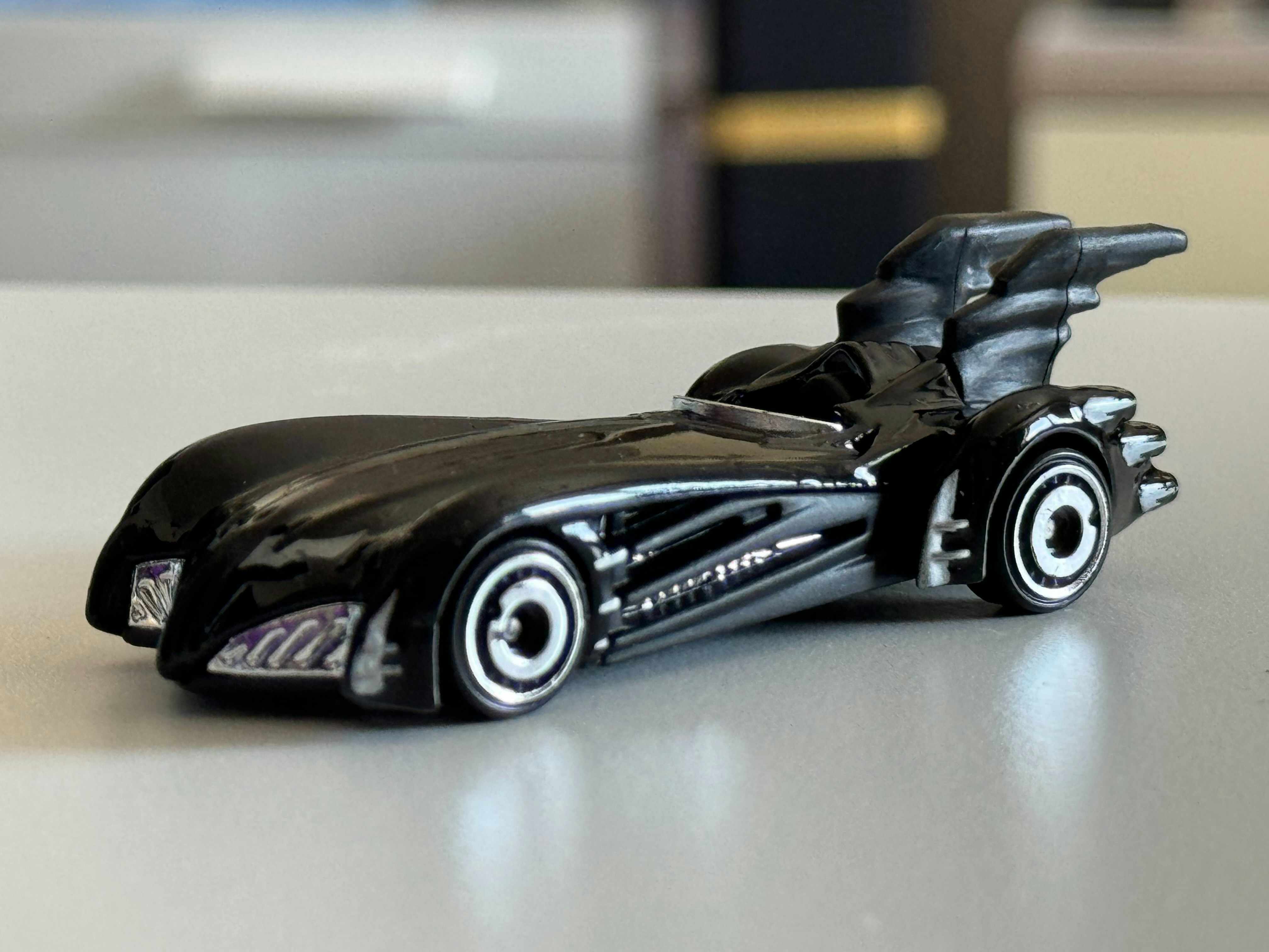 A toy batman car sitting on top of a table photo – Free Wheel Image on ...