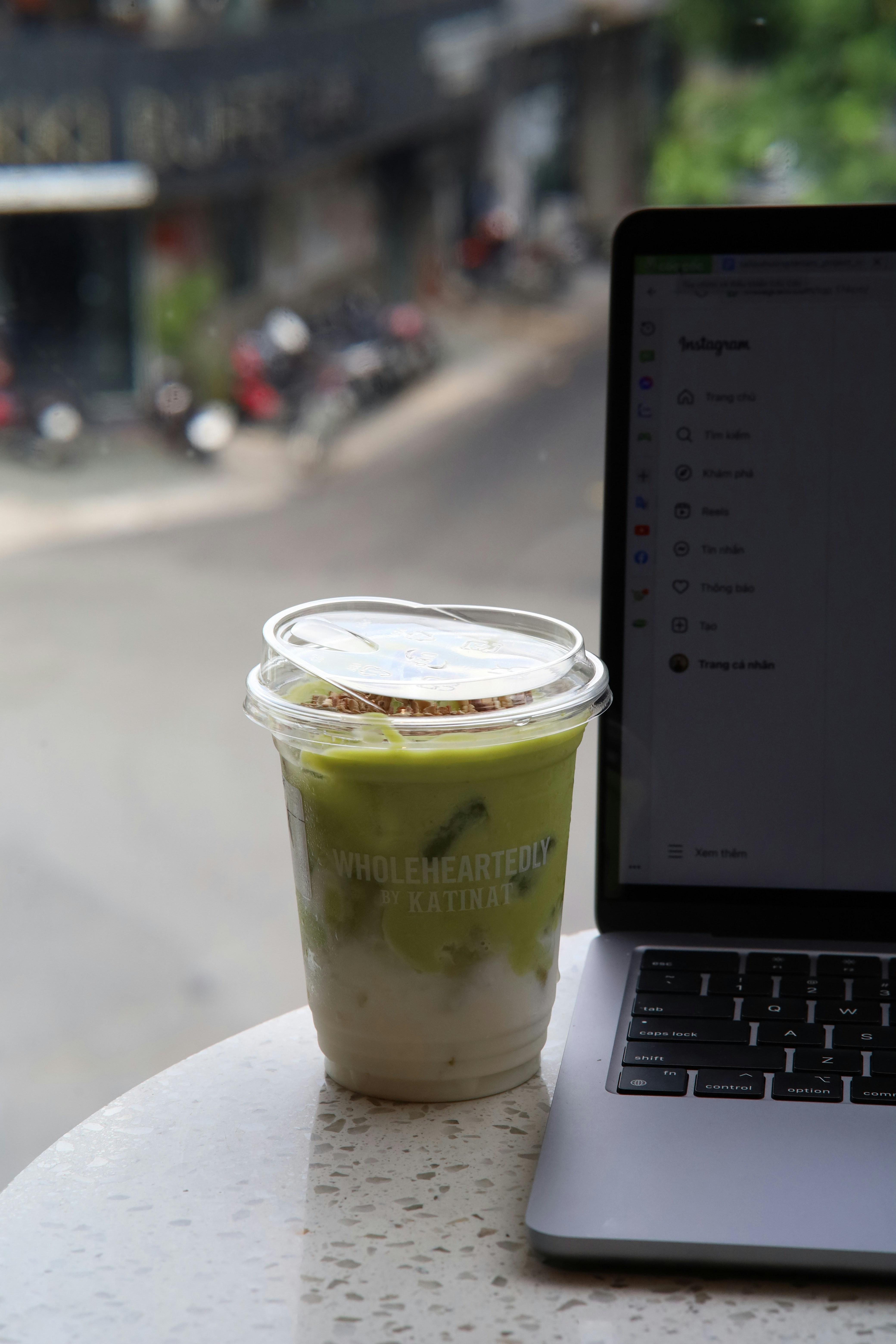 A cup of green tea next to a laptop on a table photo – Free Computer ...