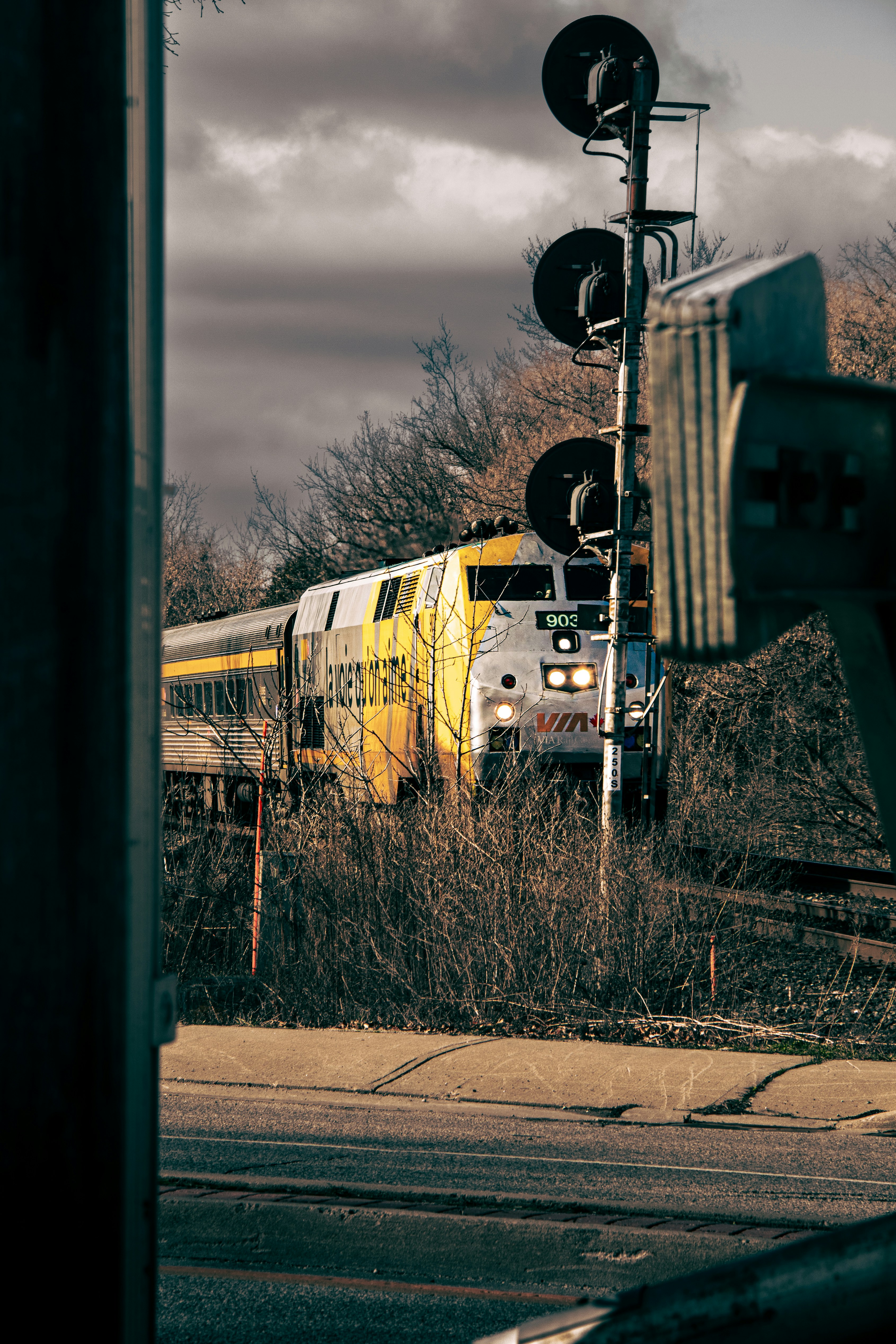 Approaching Yellow Locomotive Through a Framed Crossing
