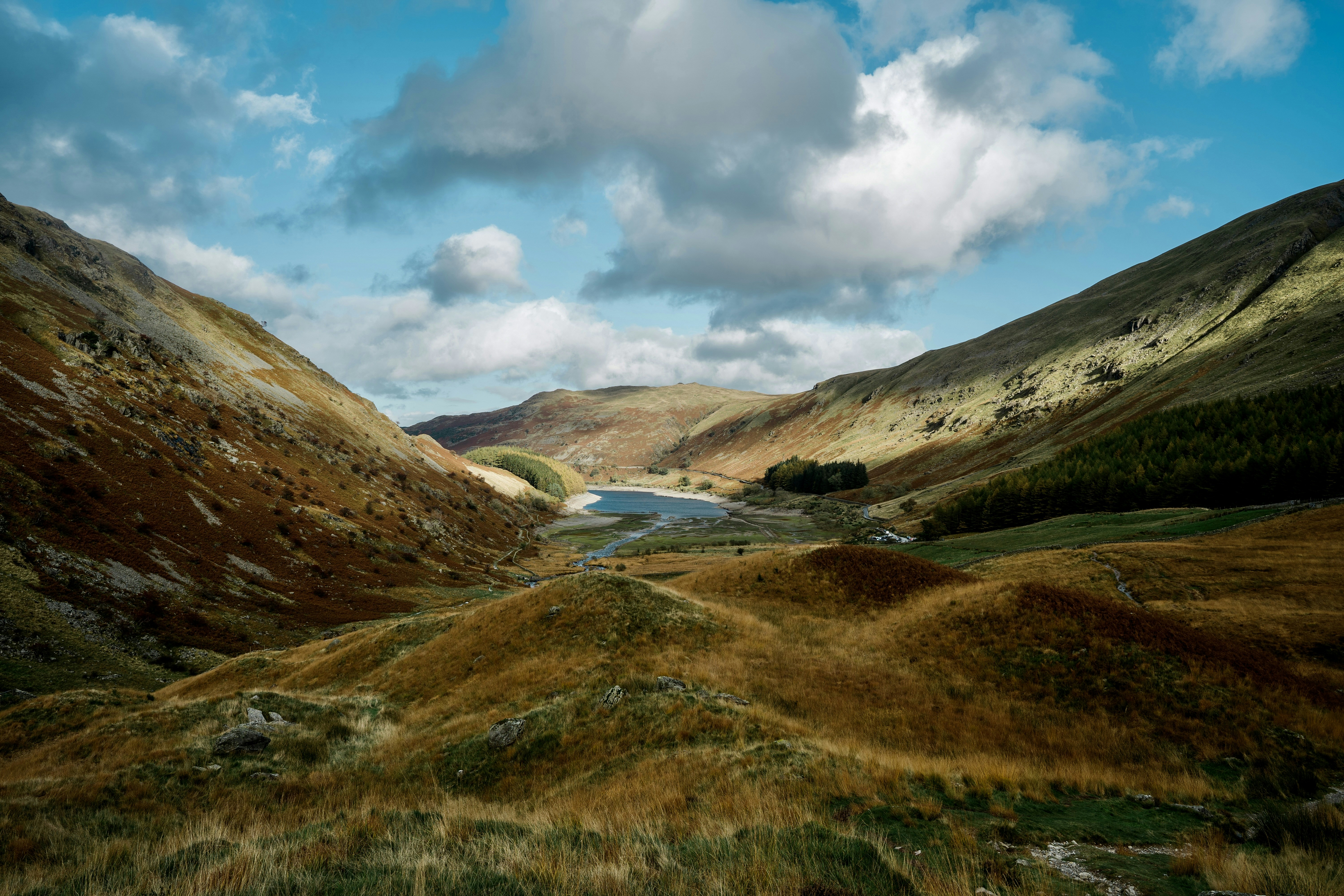 A view of a valley with a lake in the middle of it photo – Free ...