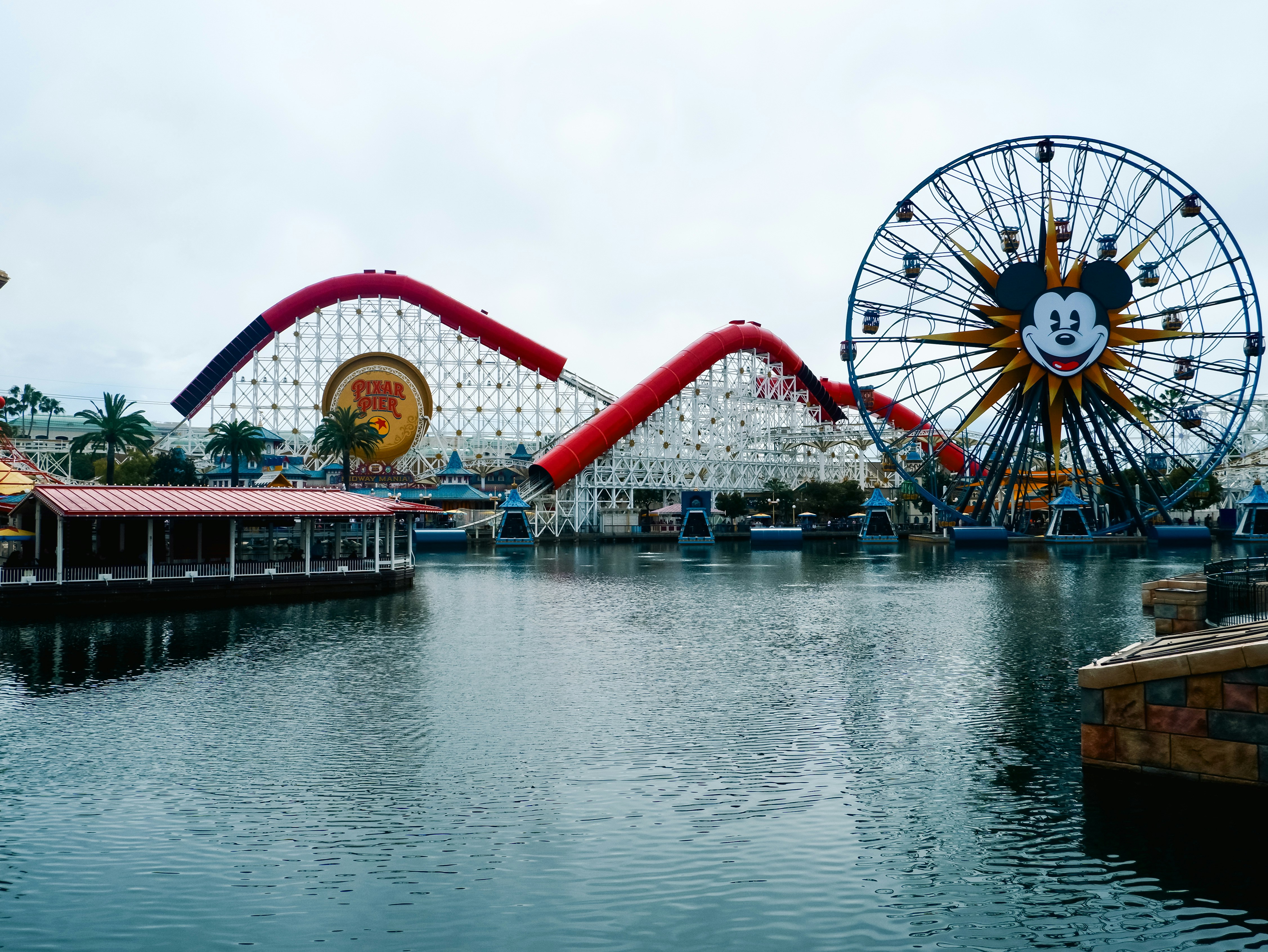 An amusement park with a ferris wheel and a mickey mouse ride photo ...