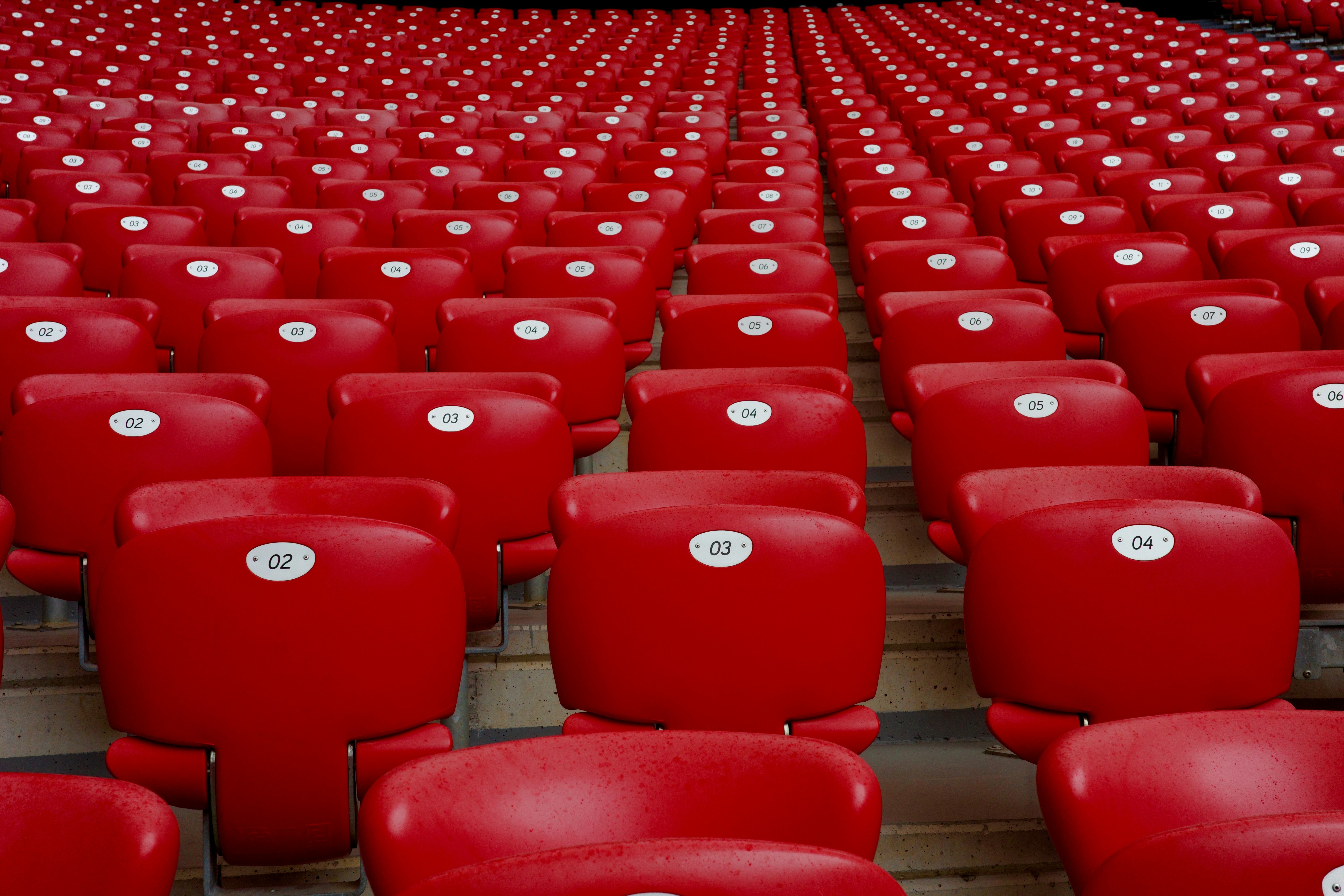 Rows of red seats in a stadium filled with red seats photo – Free ...