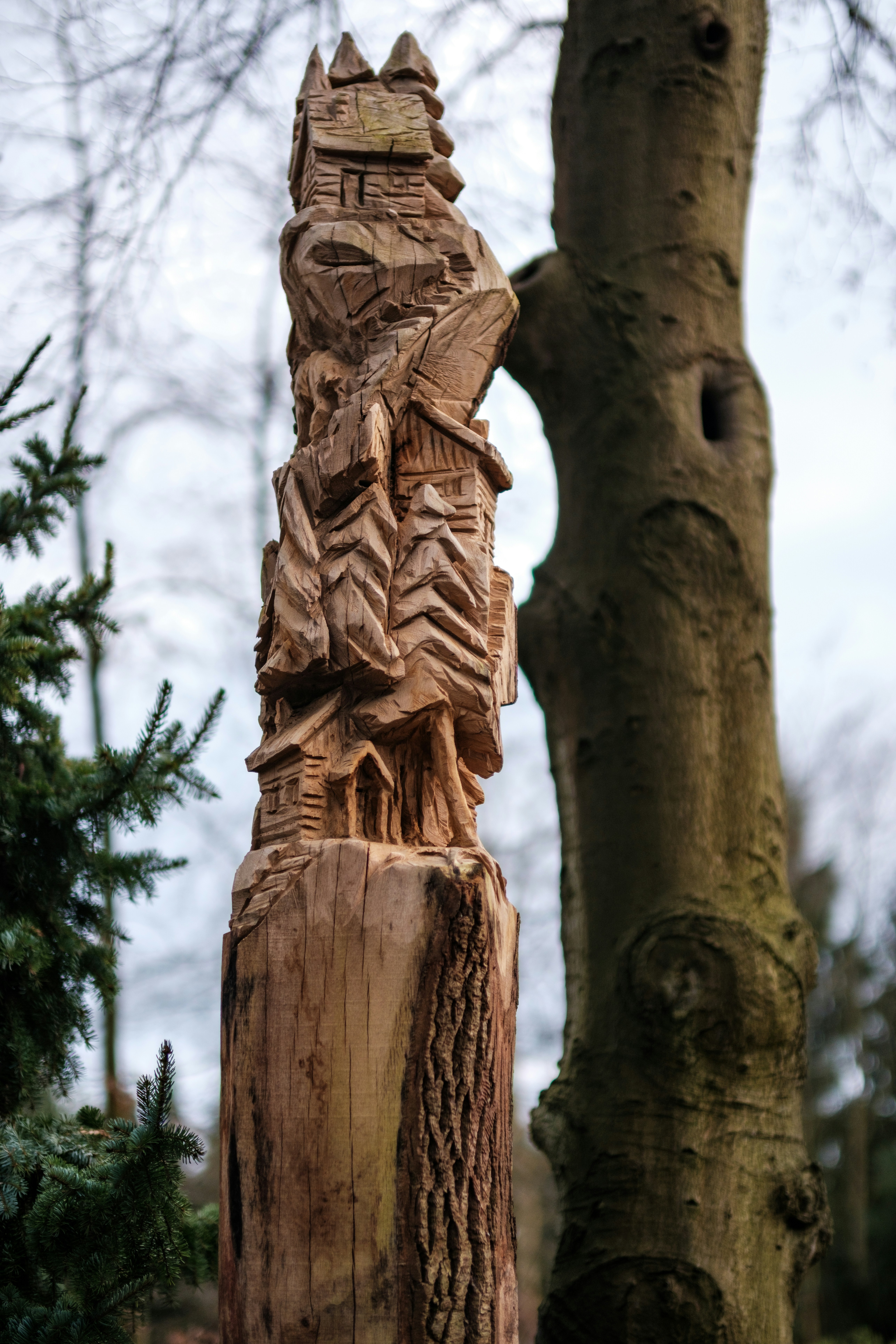 Whittled Sentinel: A Timber Guardian Rising from a Misty Forest