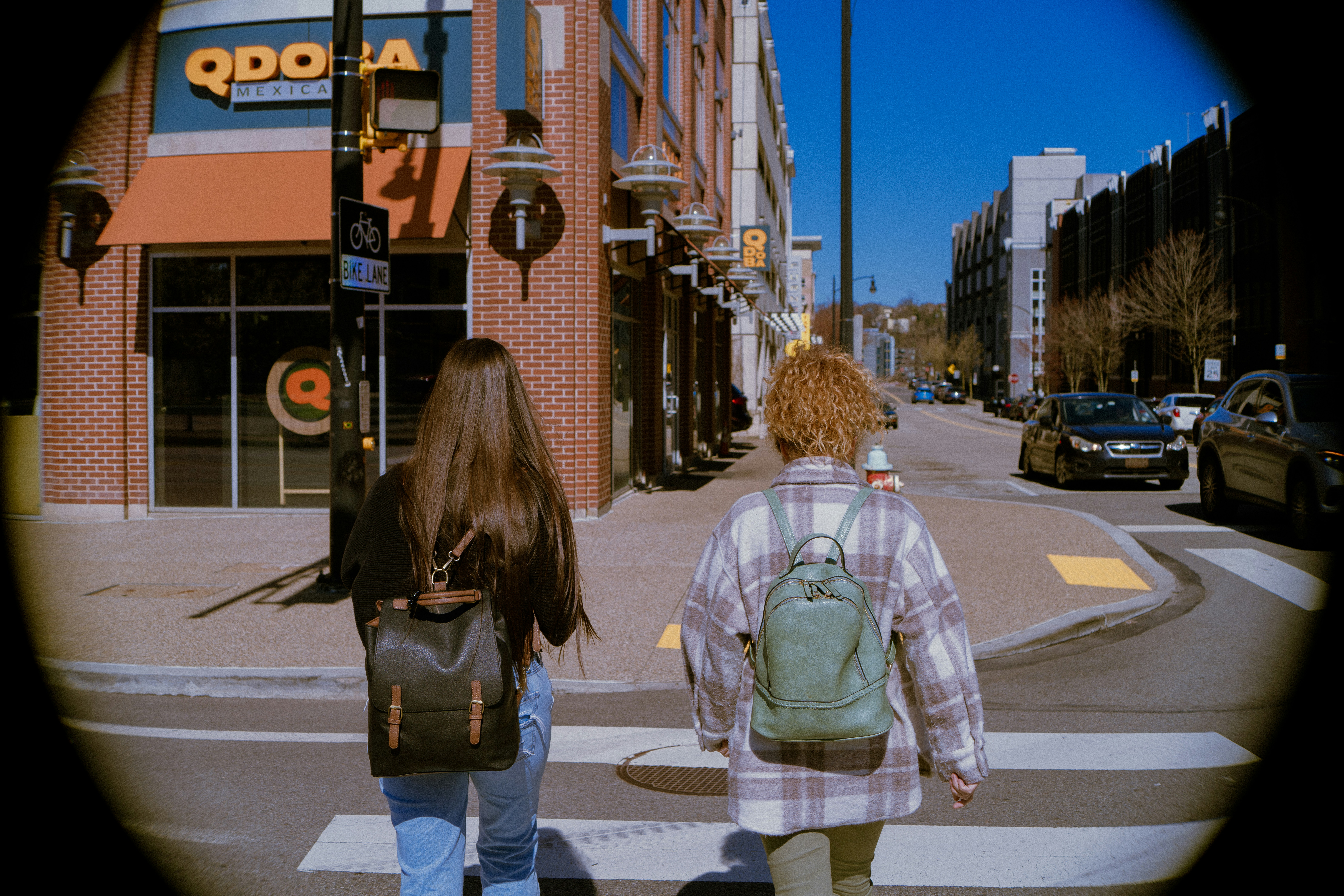Two Backpacks, City Street, and a Circular Frame