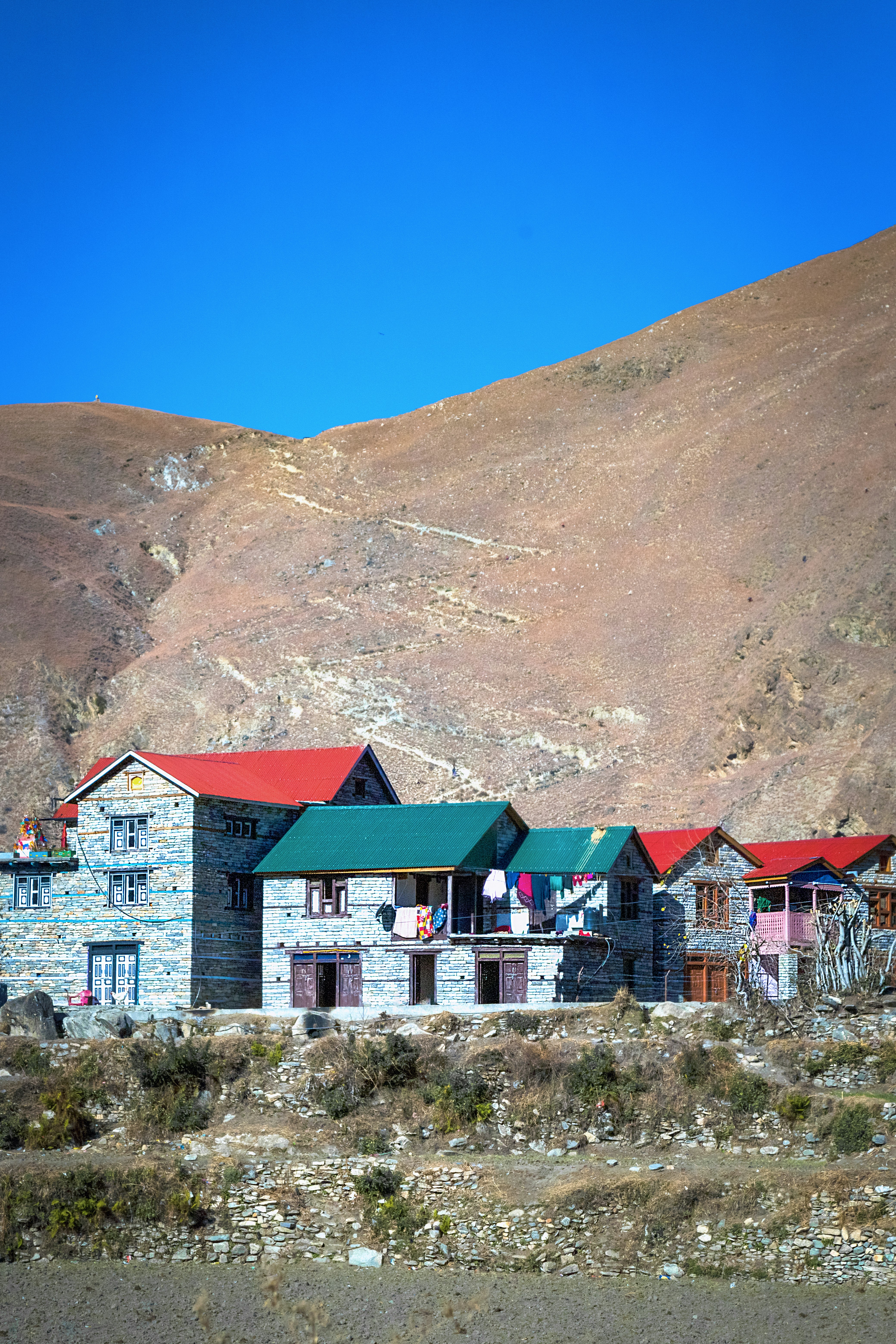 Rainbow-Roofed Hillside Village Under a Cerulean Sky
