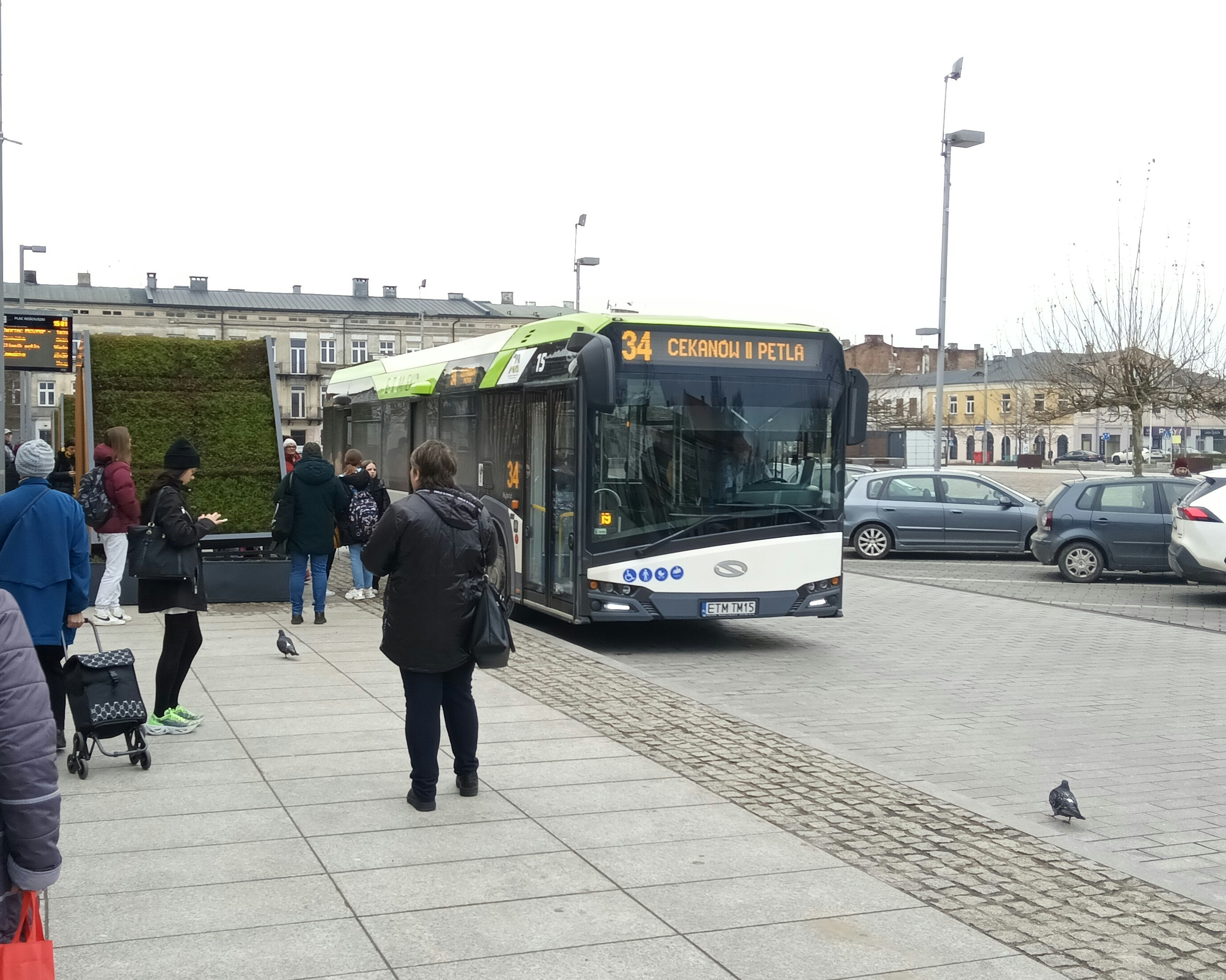 Route 34's Green-Top City Bus Halts at a Quiet Urban Plaza