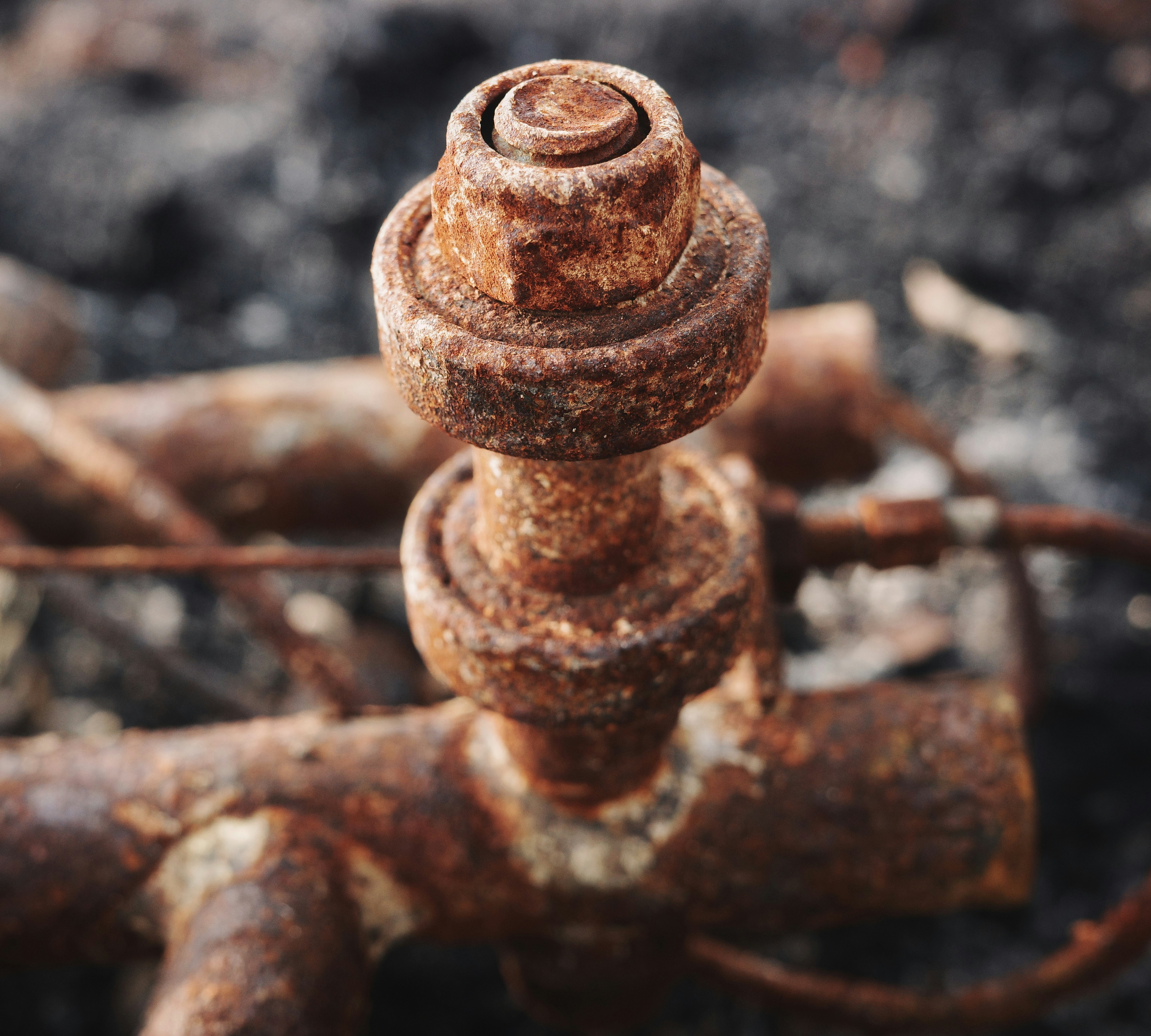 A rusted metal object sitting on top of a pile of dirt photo – Free ...