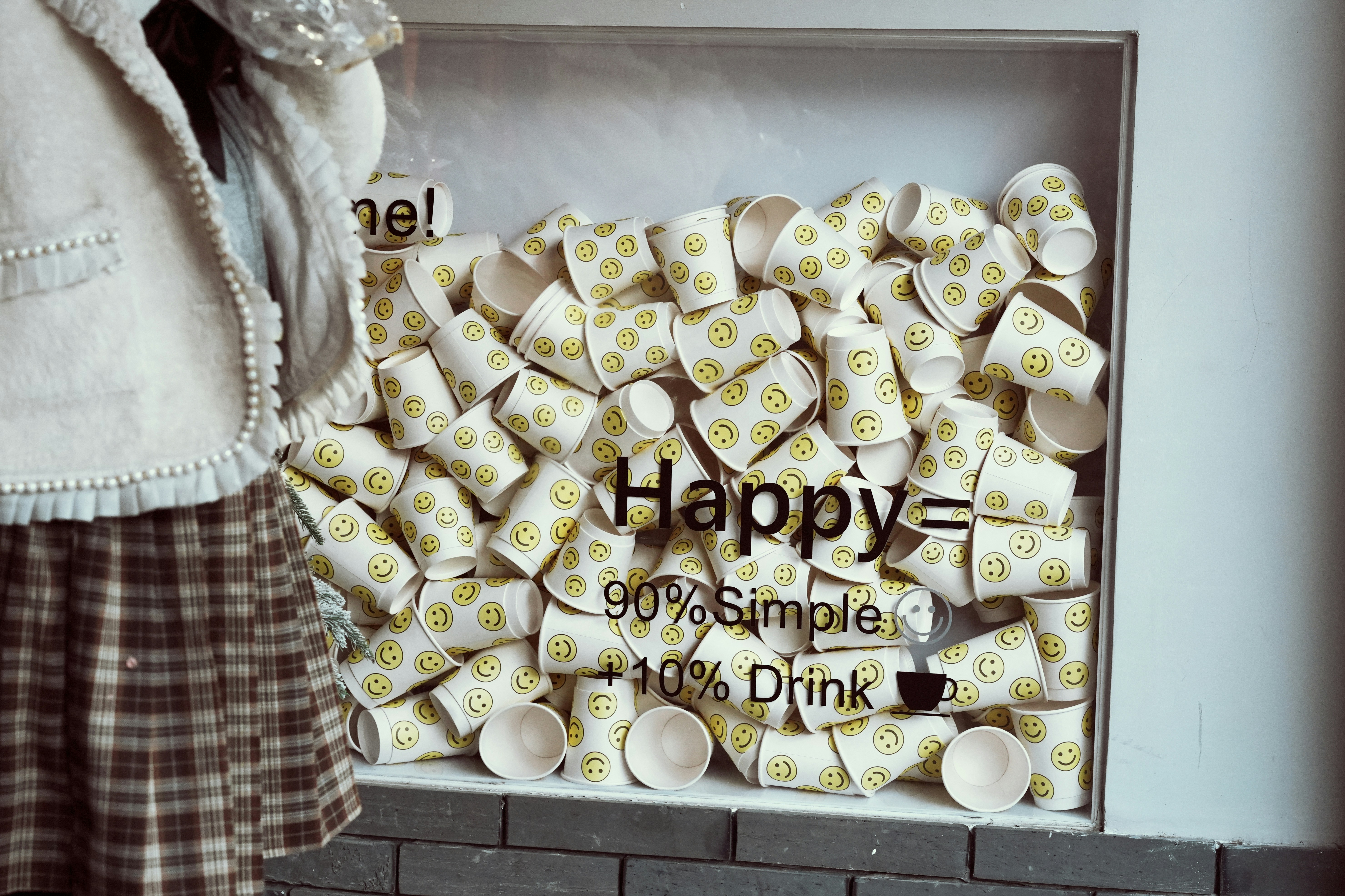 Smiley Cup Cascade Behind a Cozy Storefront Window