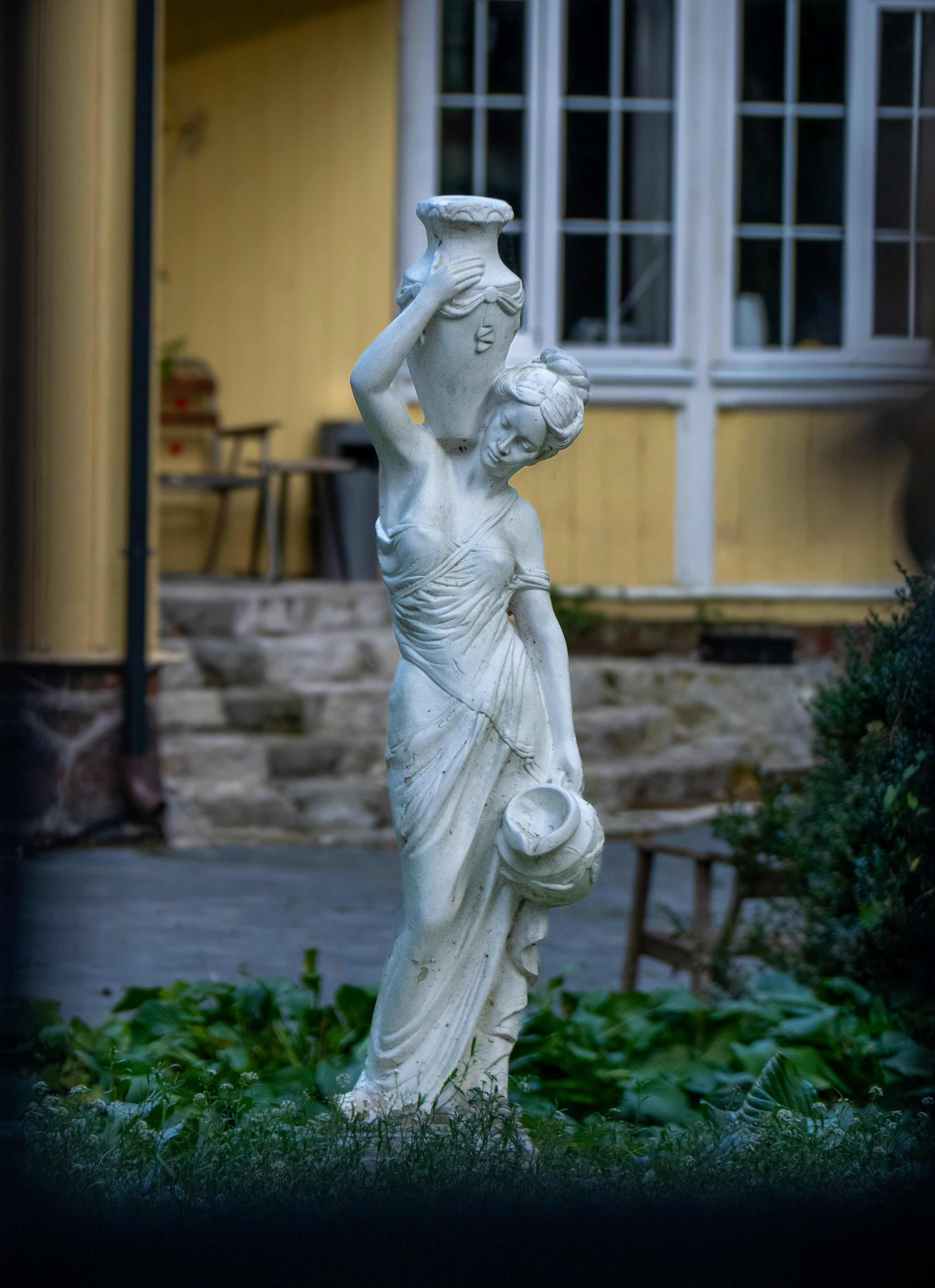 Maiden of the Vase: Marble Grace in a Sunlit Courtyard