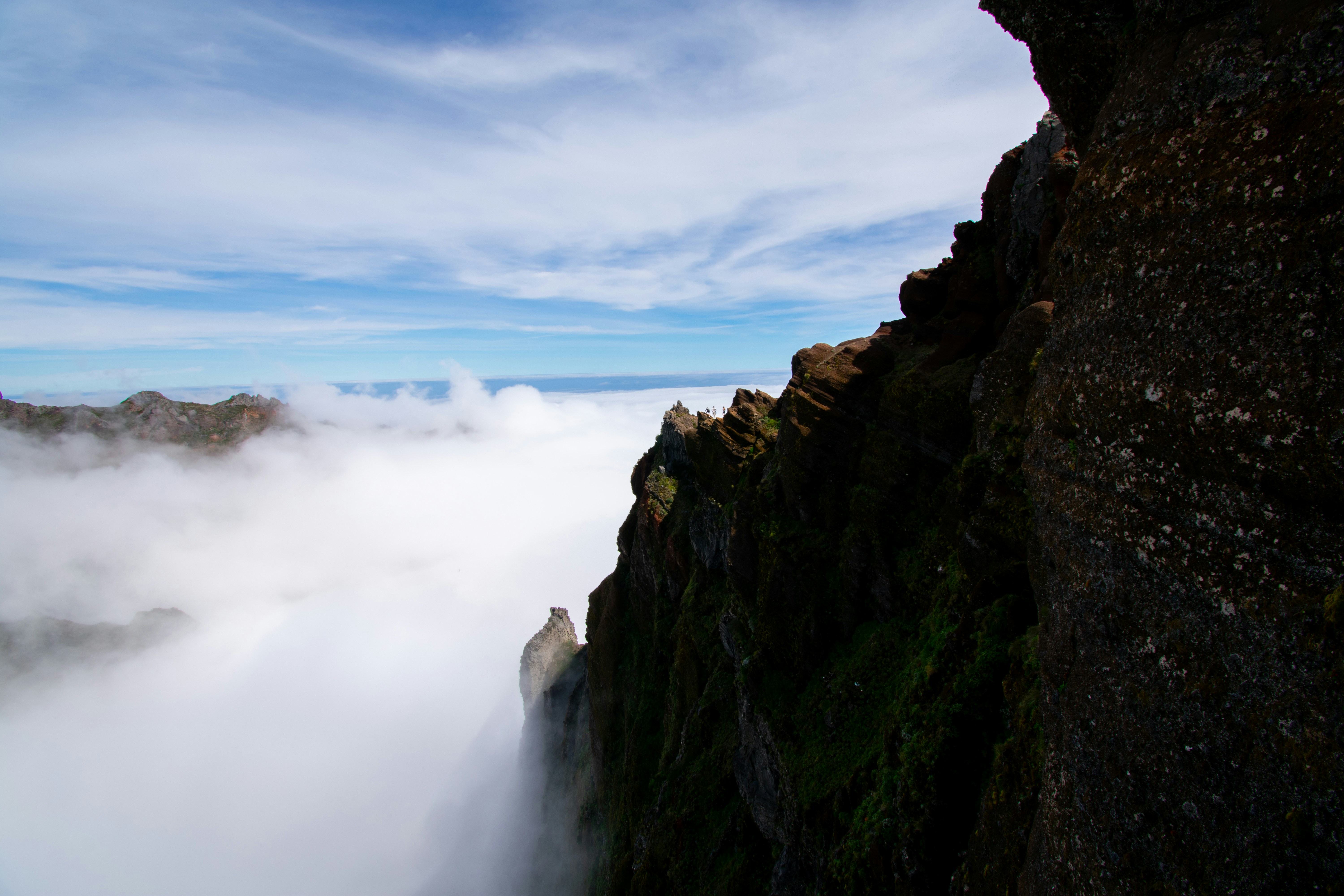 A man standing on top of a tall cliff photo – Free Madeira Image on ...