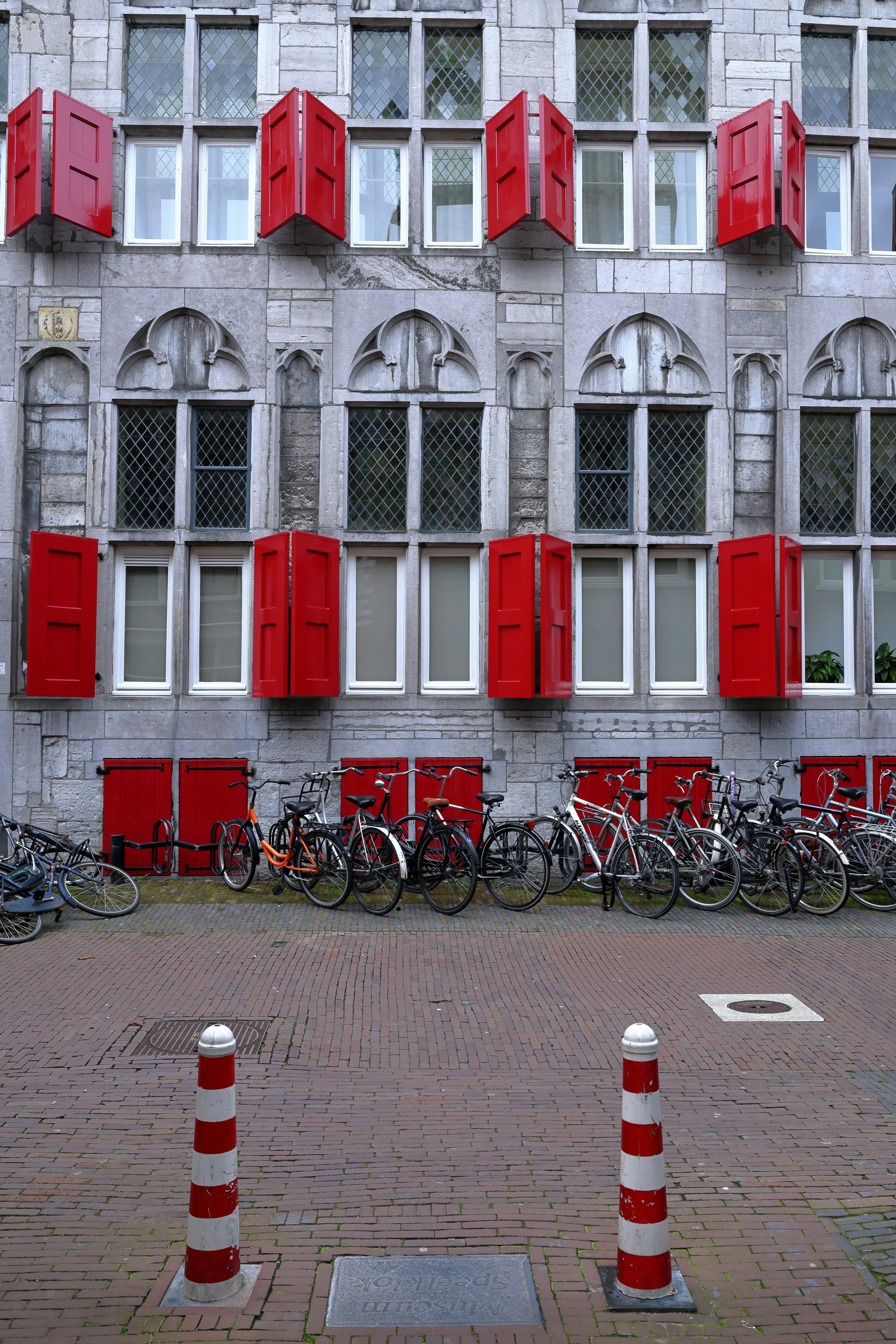Scarlet Shutters and Bicycle Lines: A Symmetrical Street Facade