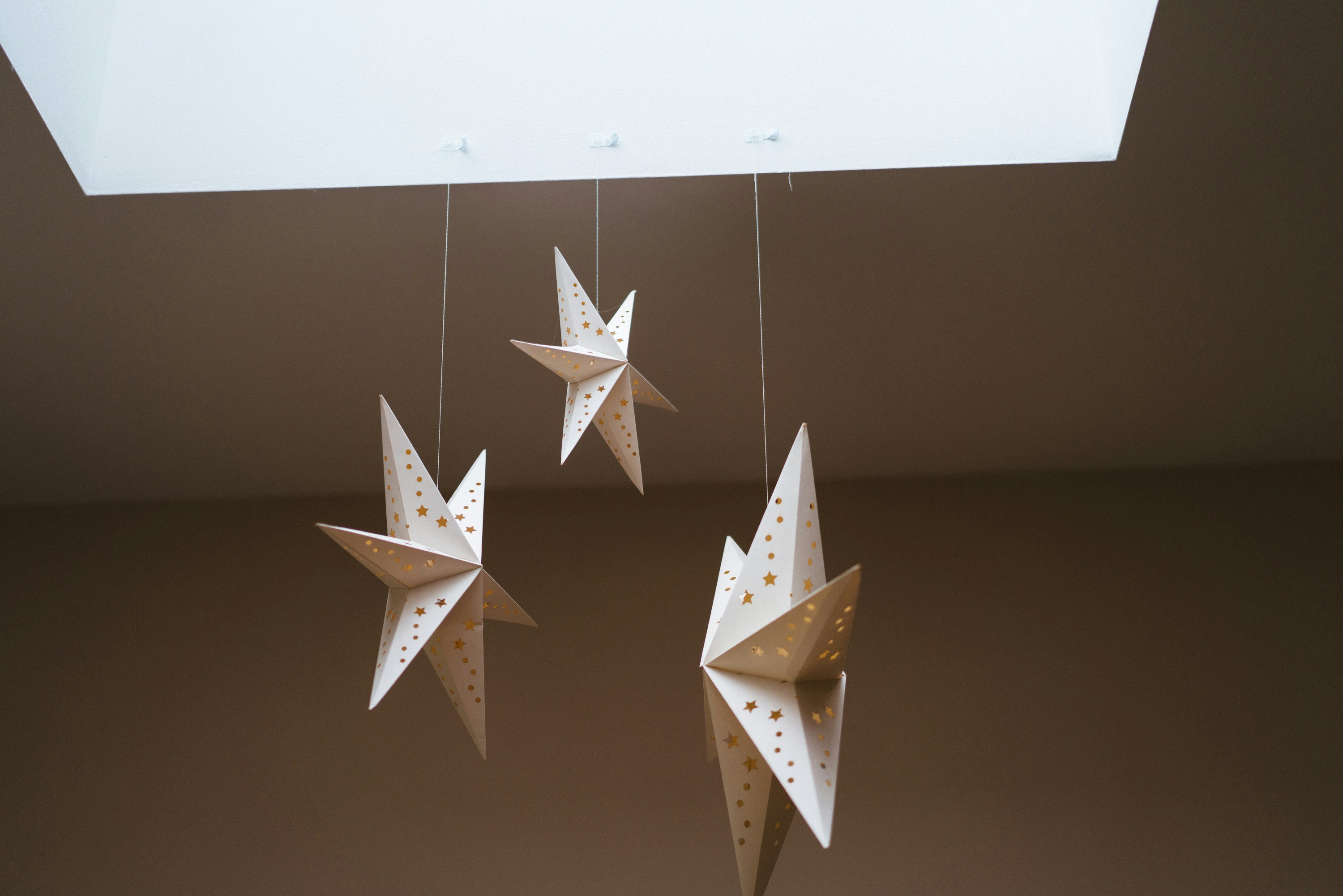 A group of paper stars hanging from a ceiling photo – Free Stars Image ...