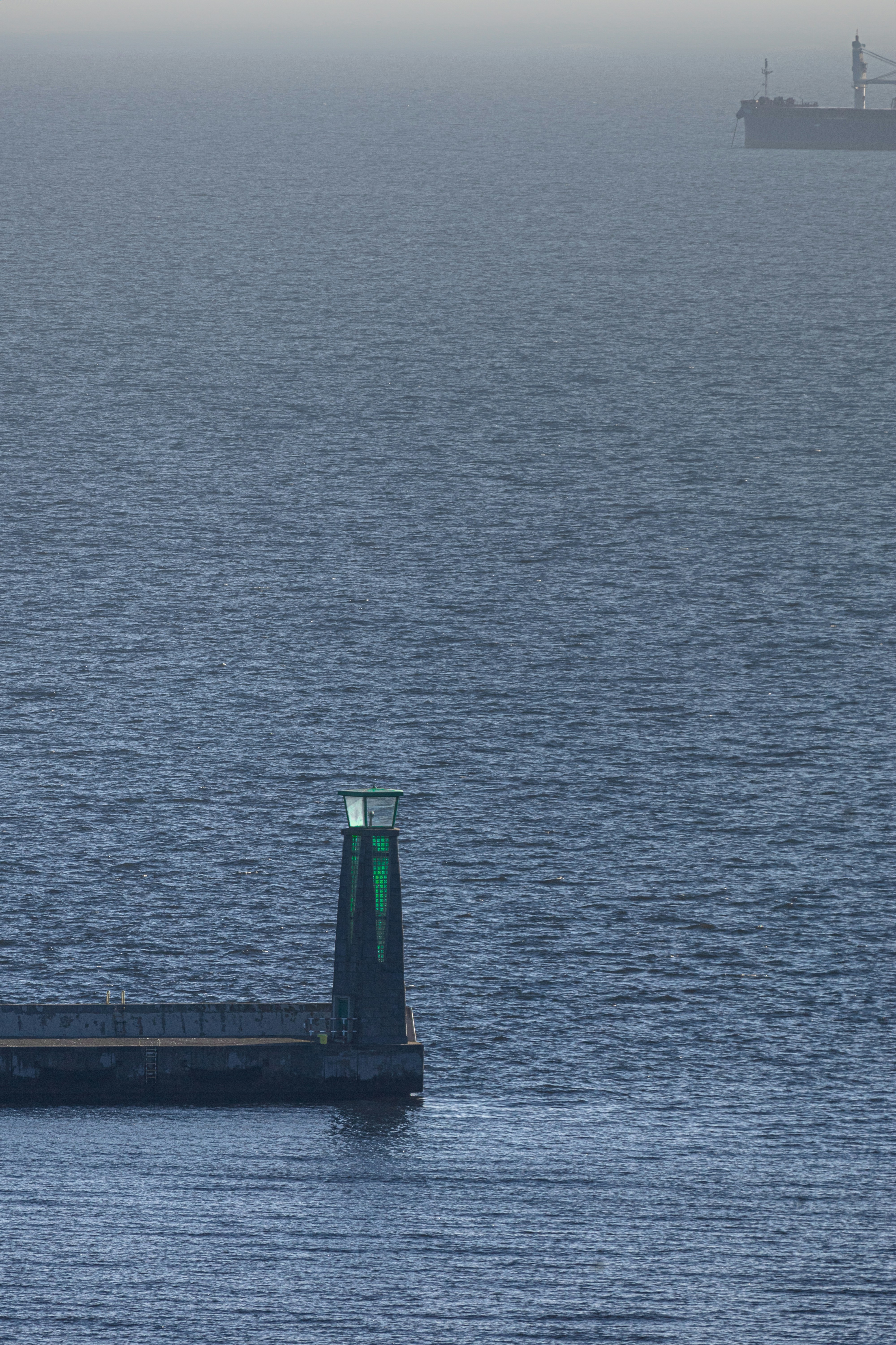Green Beacon at Sea: A Quiet Pier Adrift