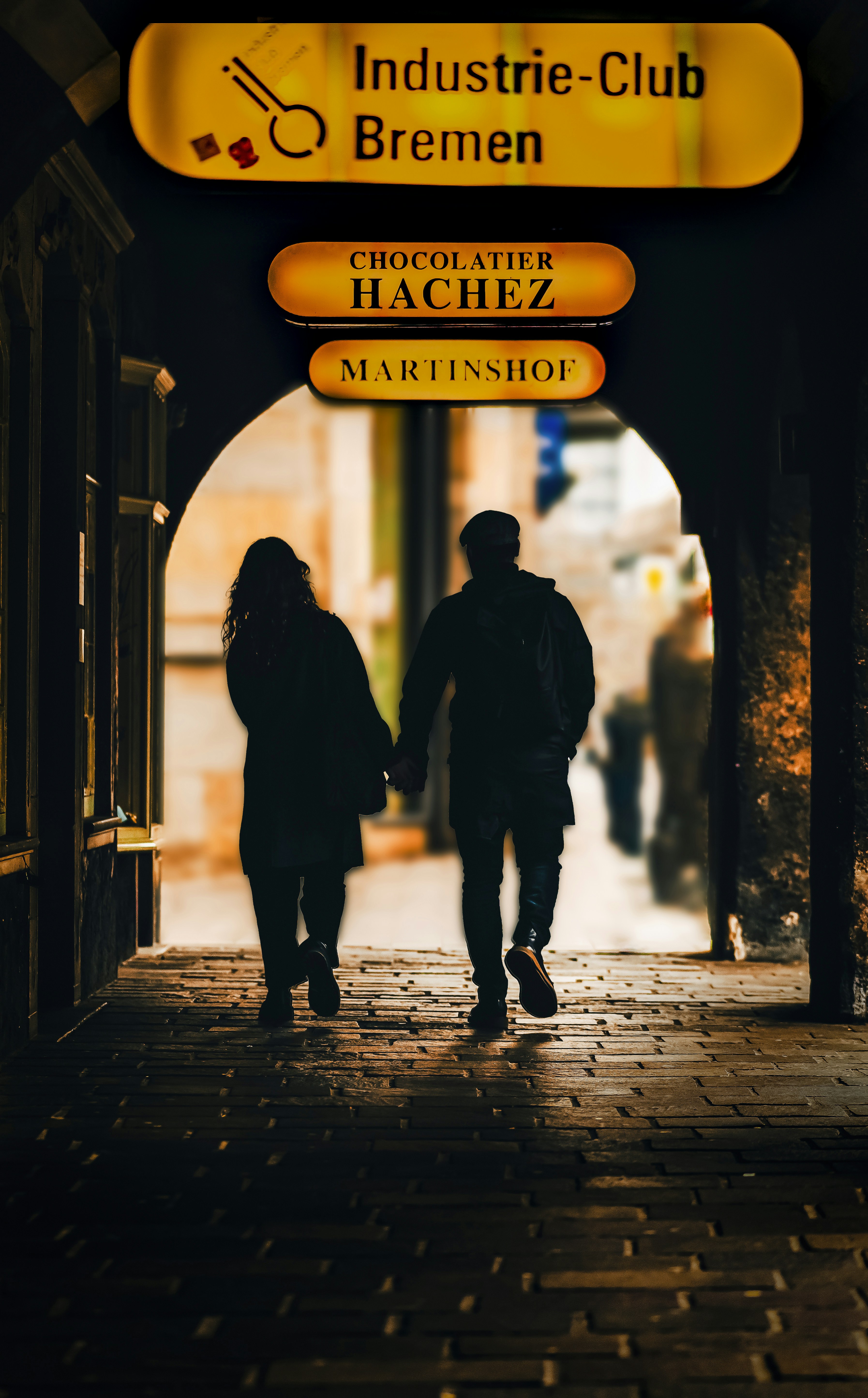 A couple of people that are walking under a sign photo – Free People ...