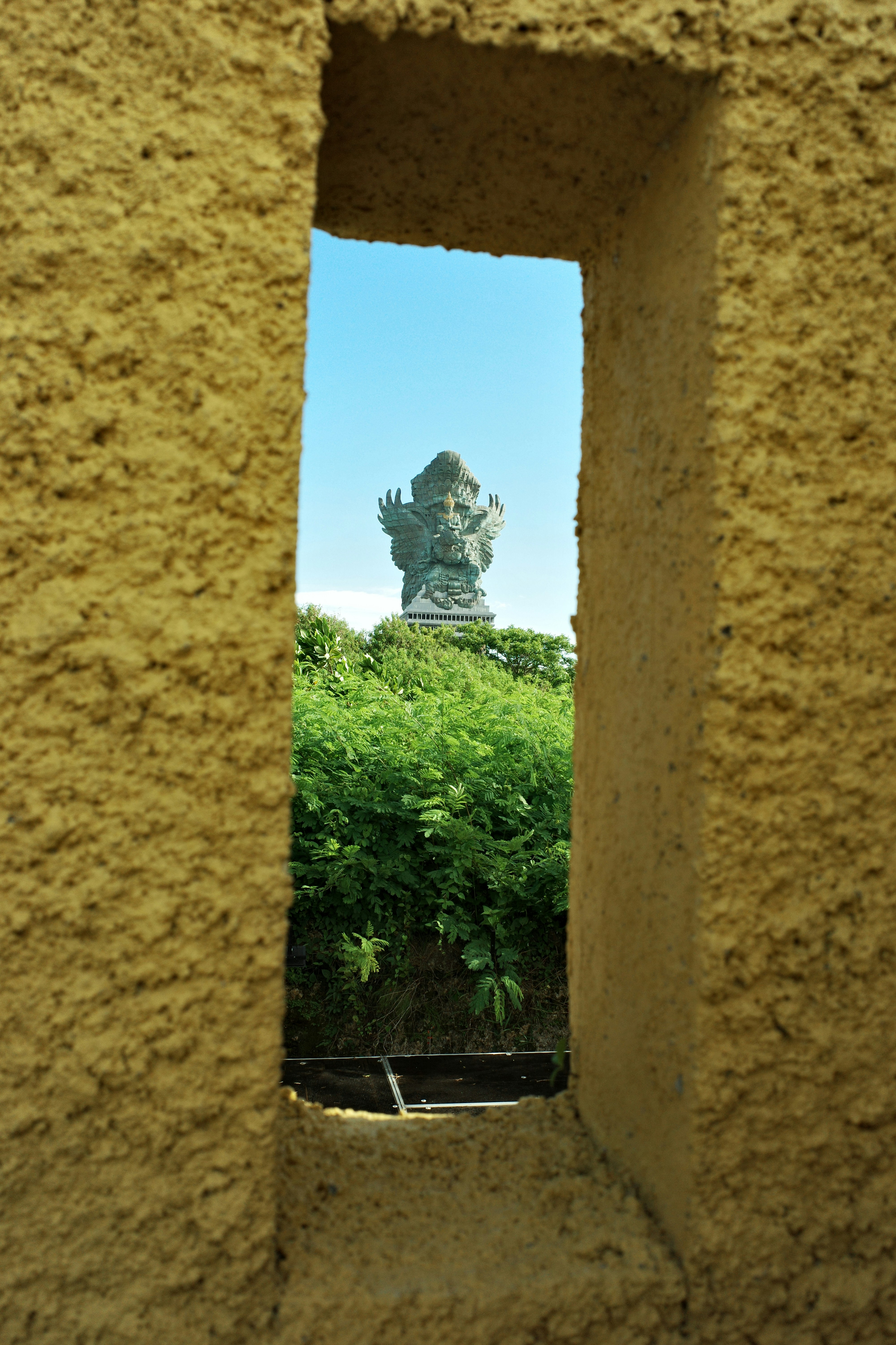 Winged Sentinel Framed by a Sunlit Sandstone Window