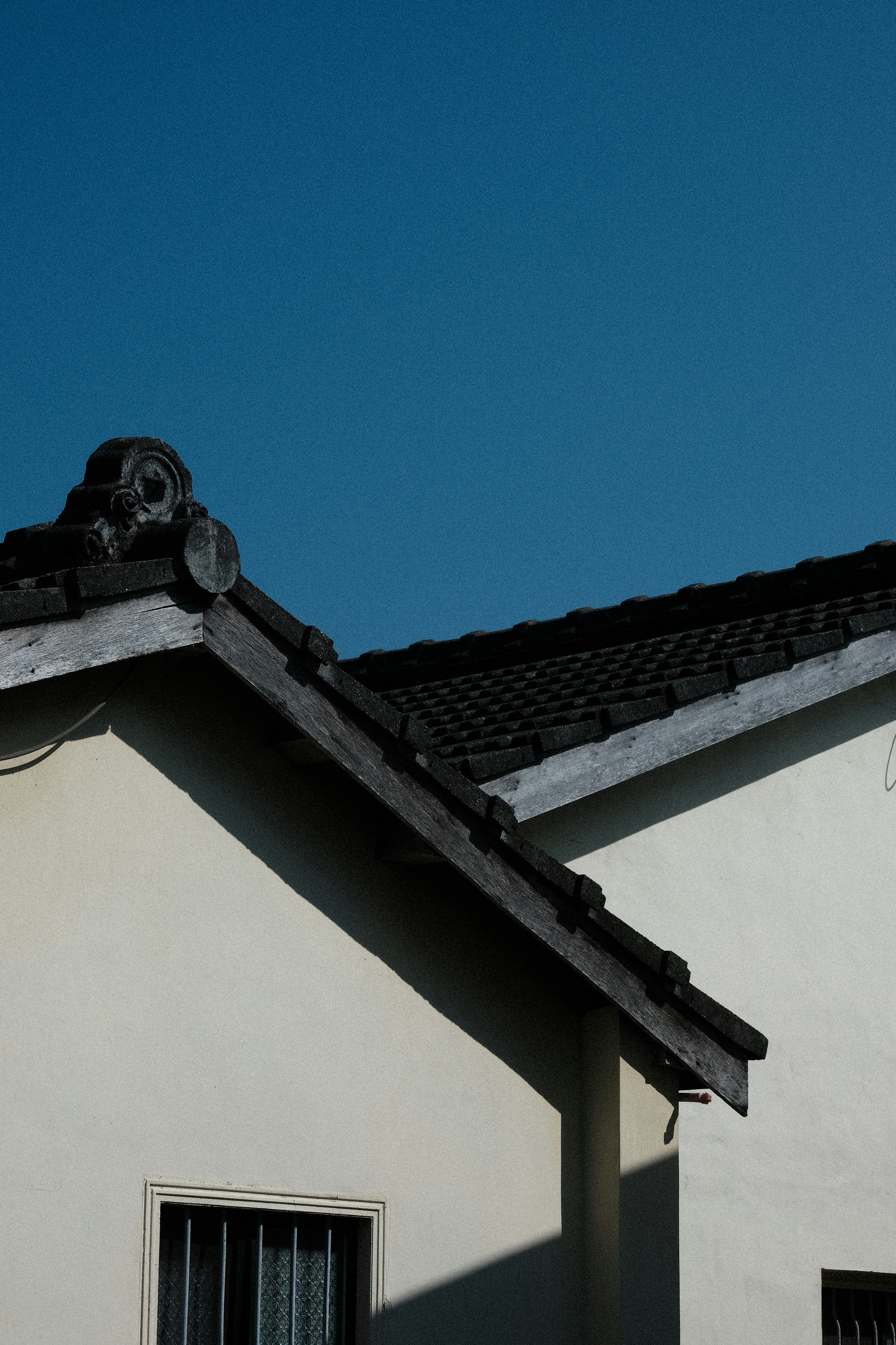 Shadowed eaves under a cobalt sky