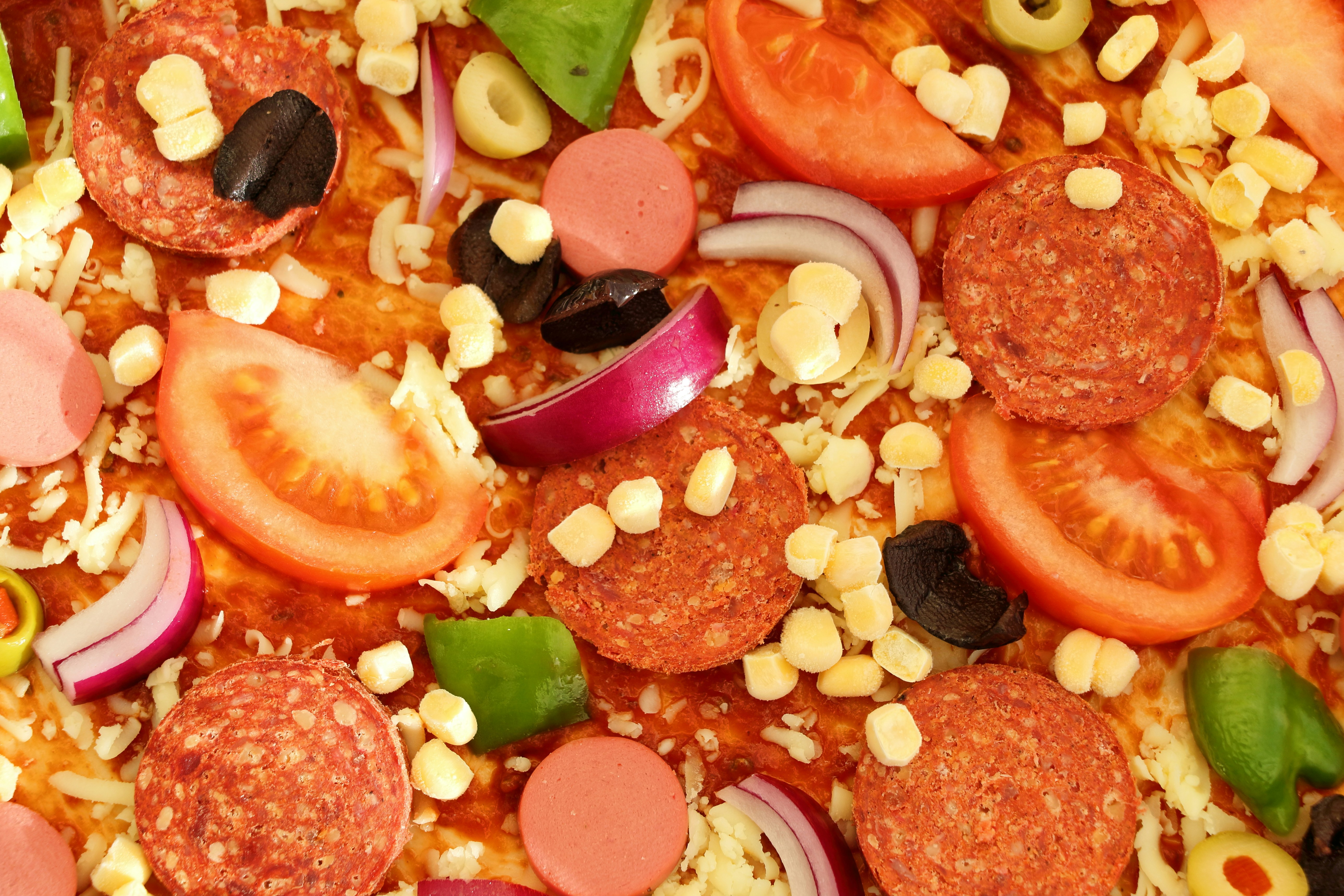 A pizza topped with lots of toppings on top of a table photo – Free ...