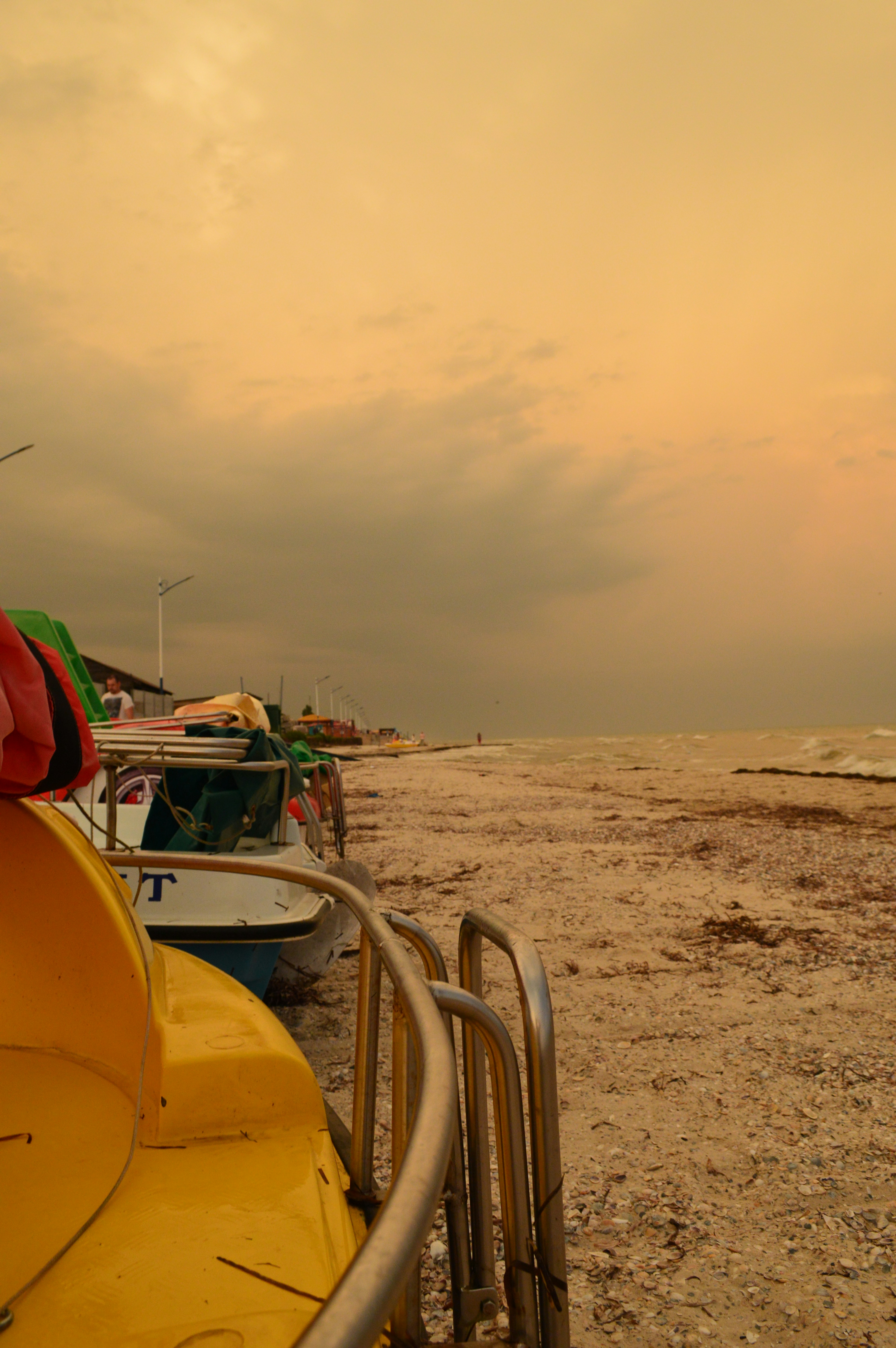 Amber Hour: Row of Colorful Boats Align Along a Quiet Beach