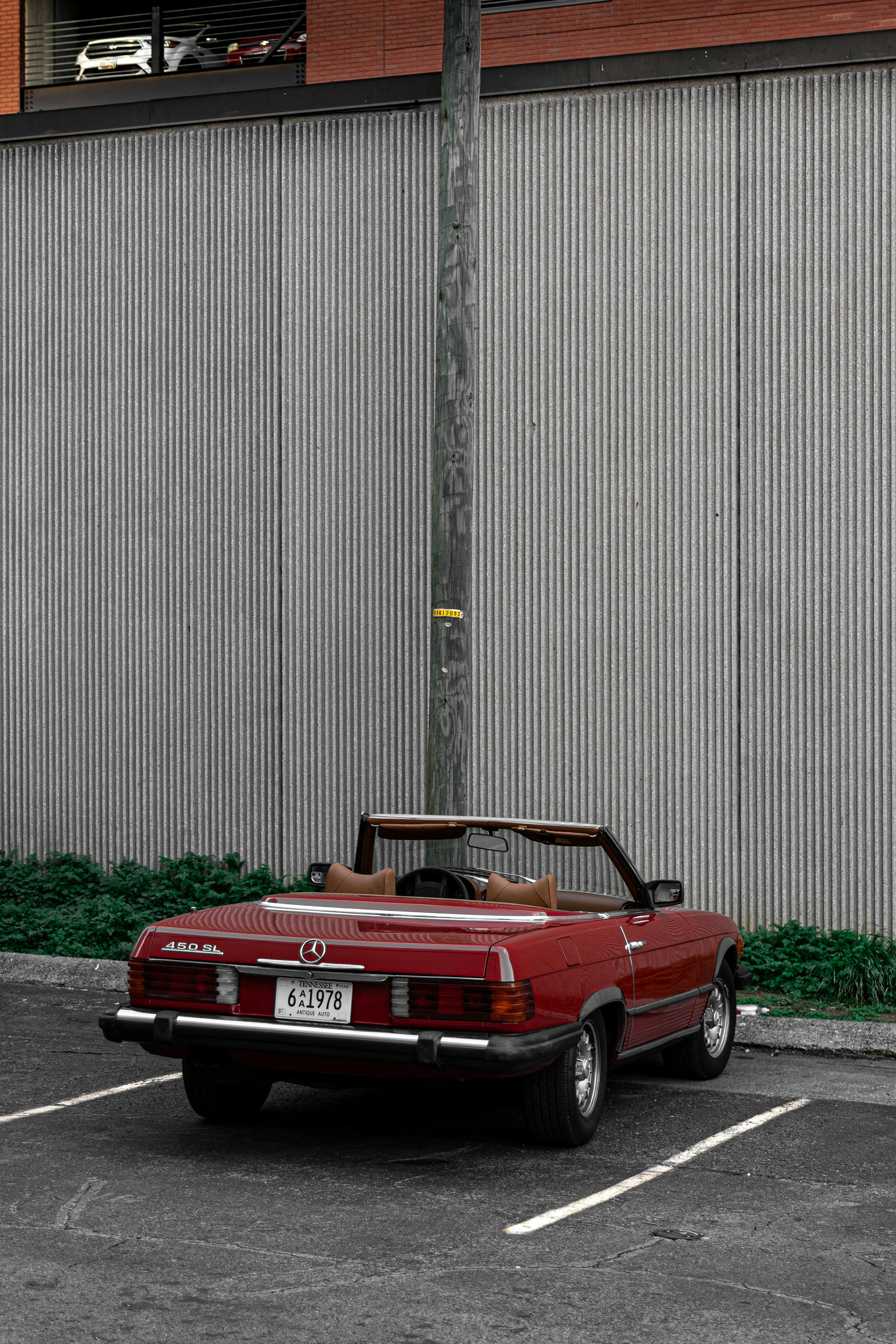 Crimson Mercedes Convertible Anchored in a Quiet Industrial Backdrop