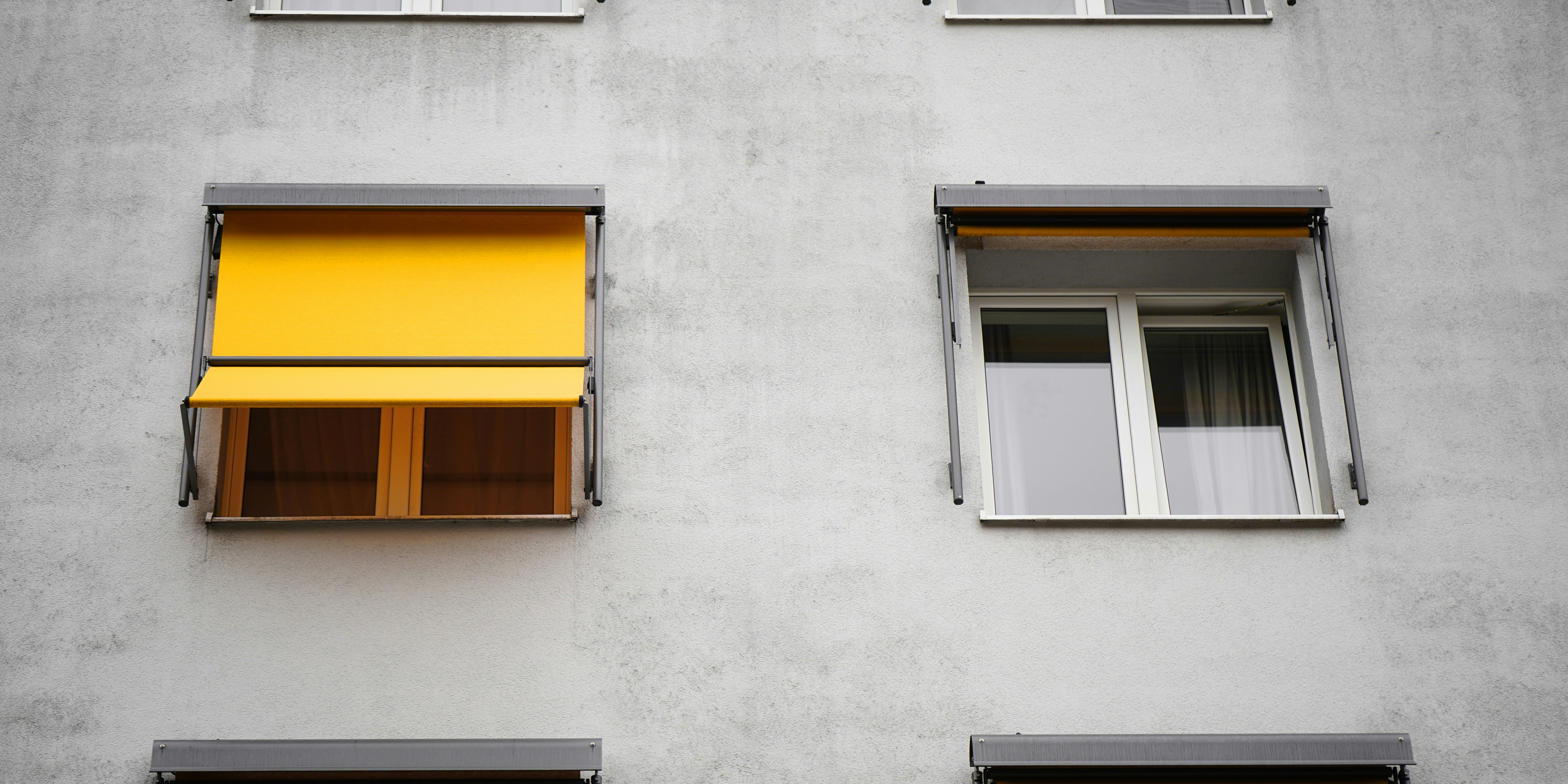 Amber Window on a Quiet Concrete Facade