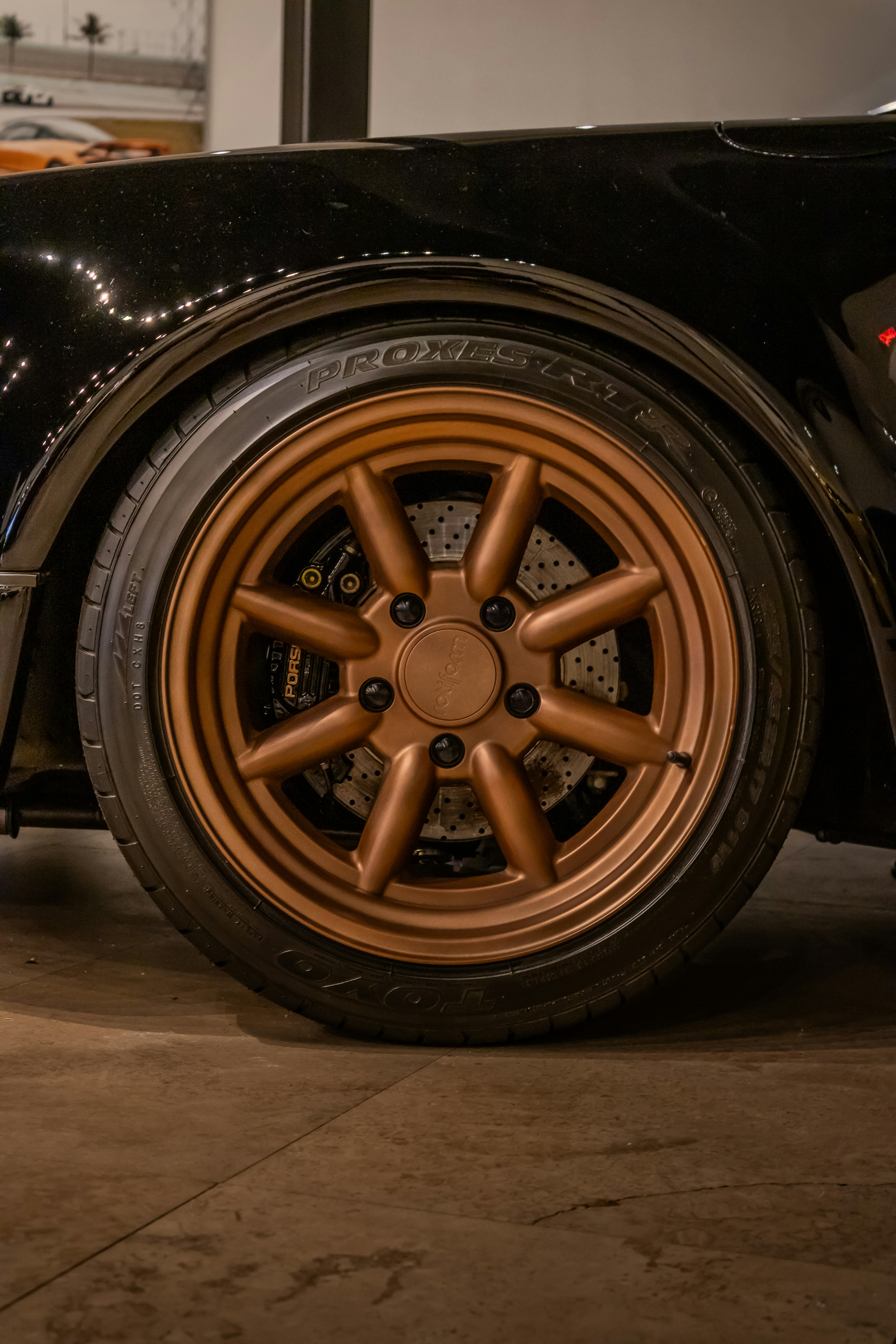 Bronze Spokes in Focus: A Close-Up on the Car's Performance Wheel