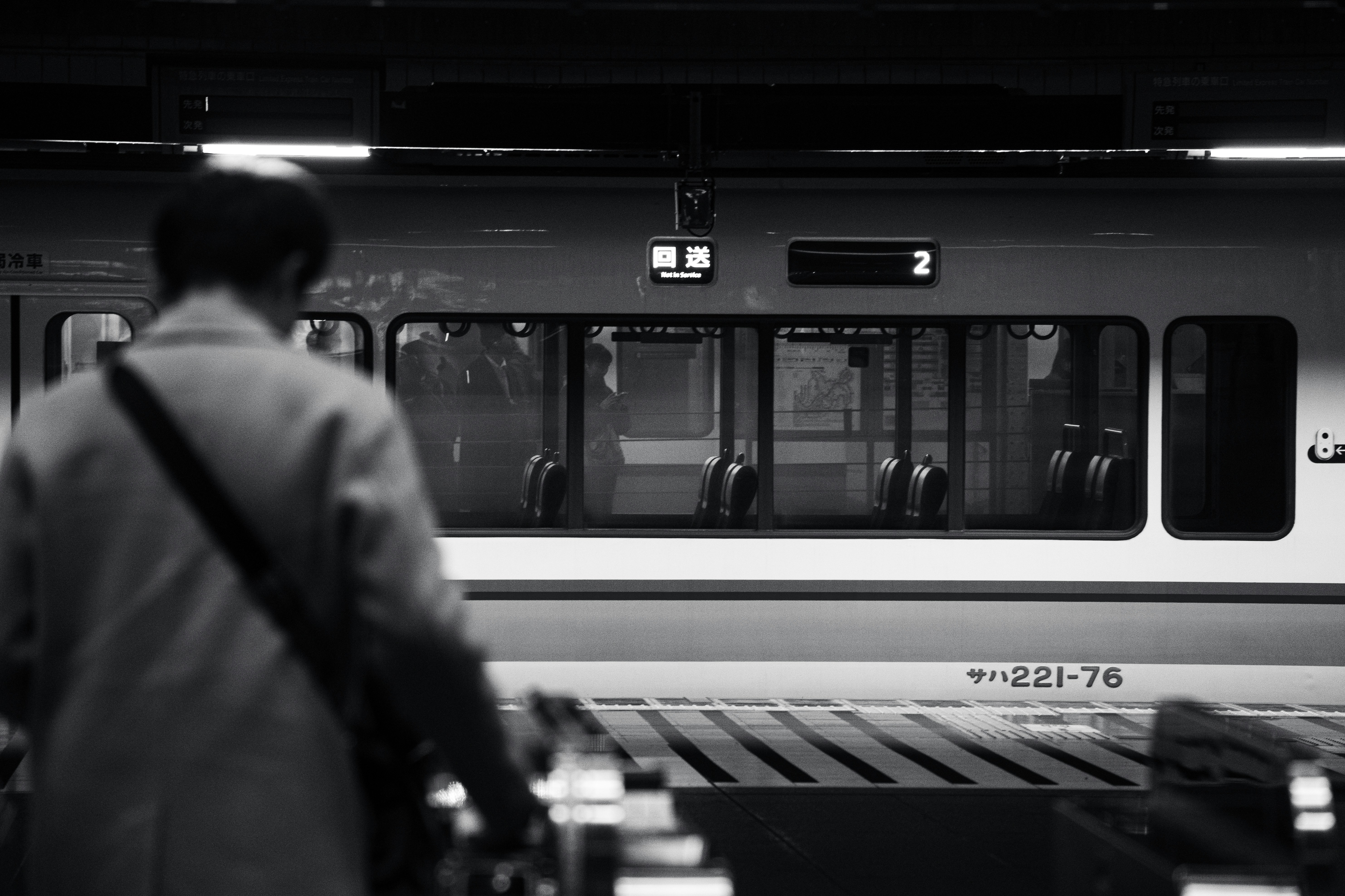 A man standing in front of a train at a train station photo – Free ...