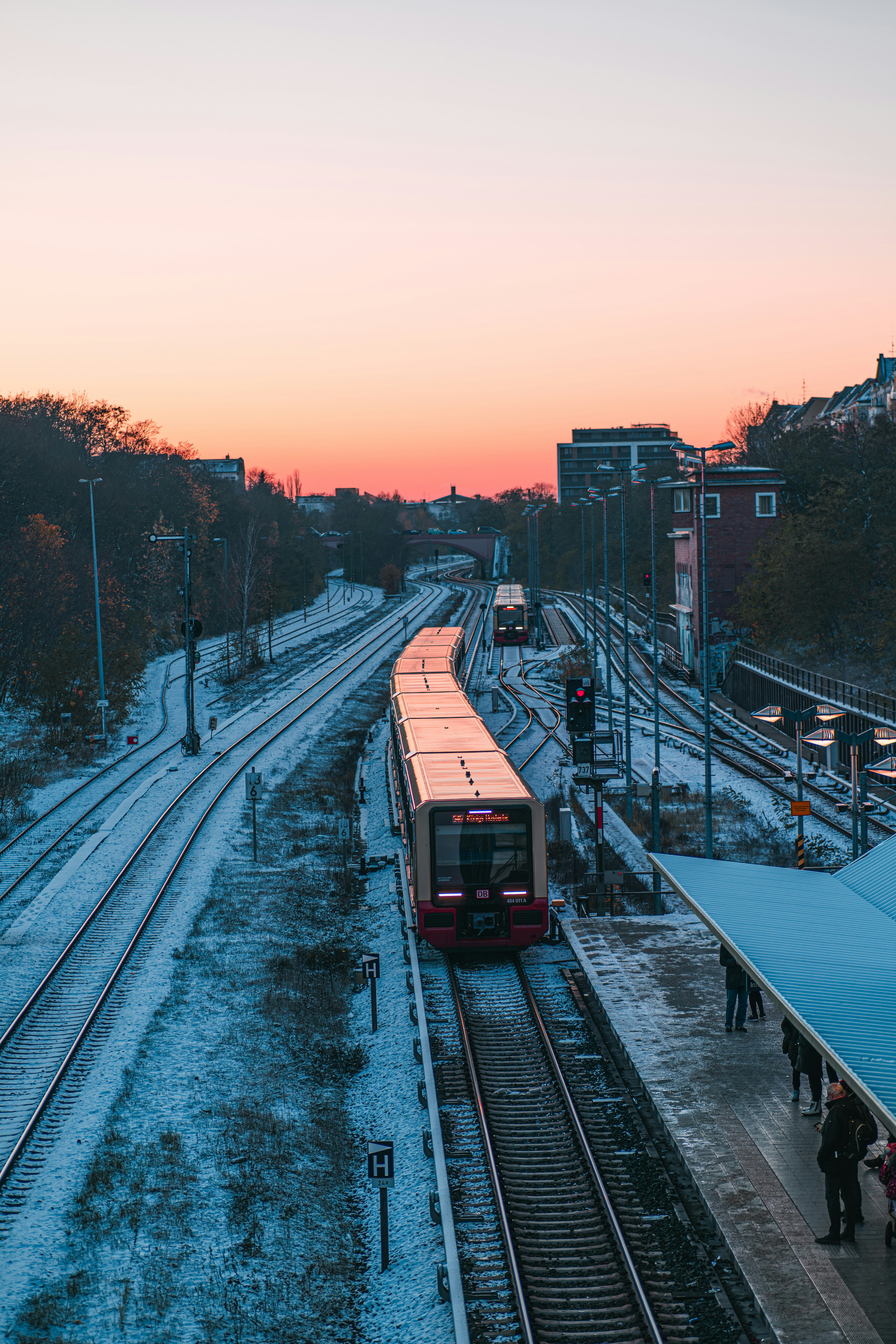 Dusk Rails: Frost-Kissed Tracks and a Crimson Commuter