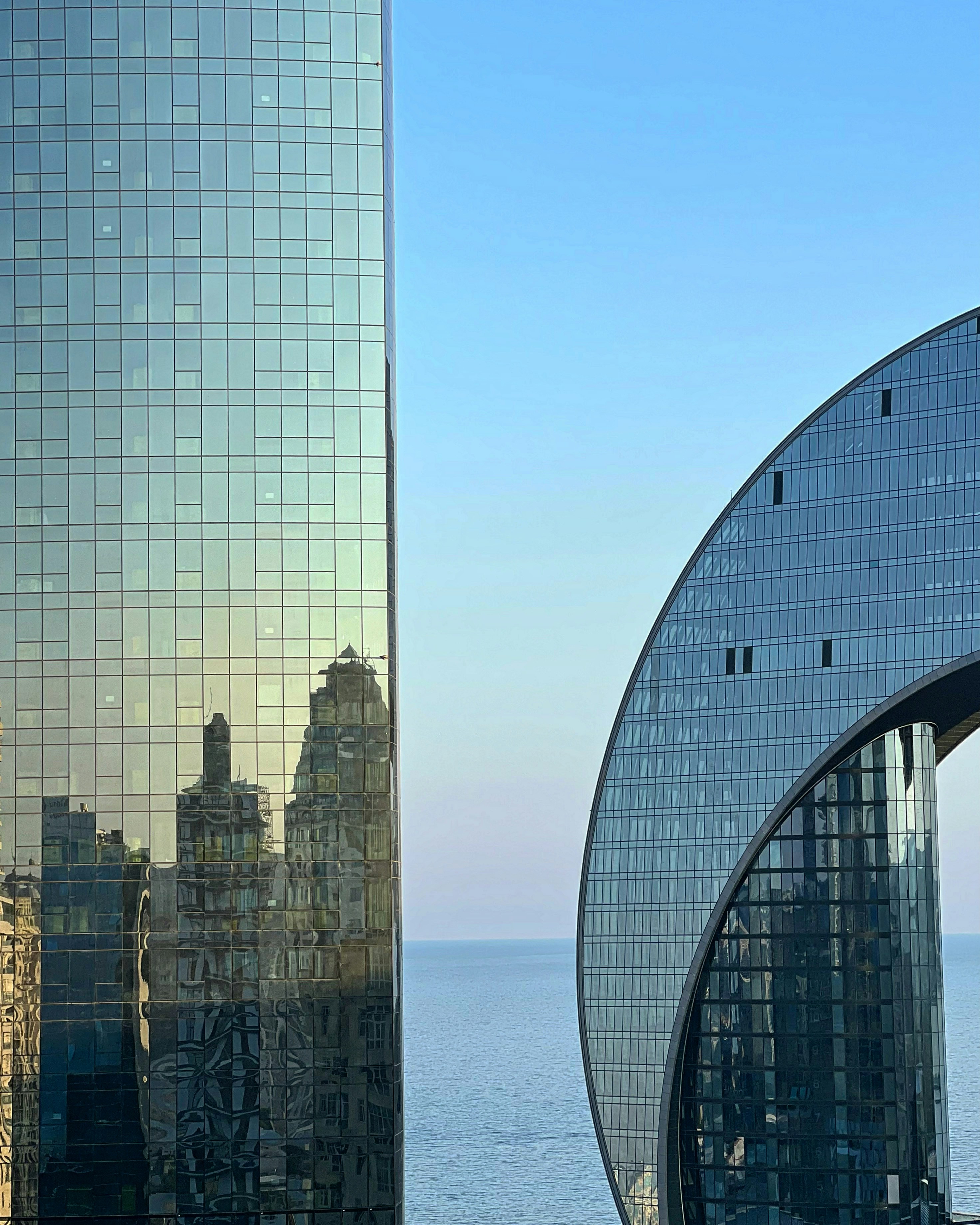 Glass Between Harbor and Sky: City Reflections