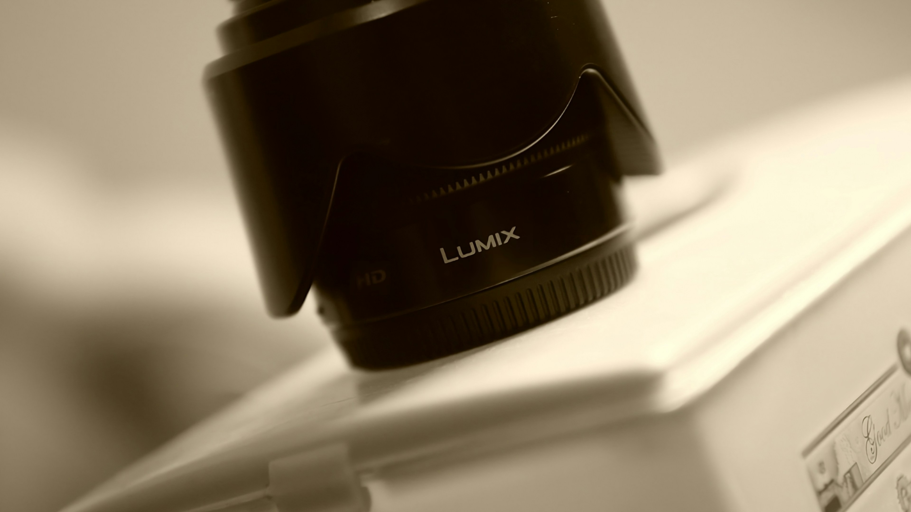 Lumix kit lens 14-42mm f3.5-5.6 Mega OIS. | a camera lens sitting on top of a refrigerator