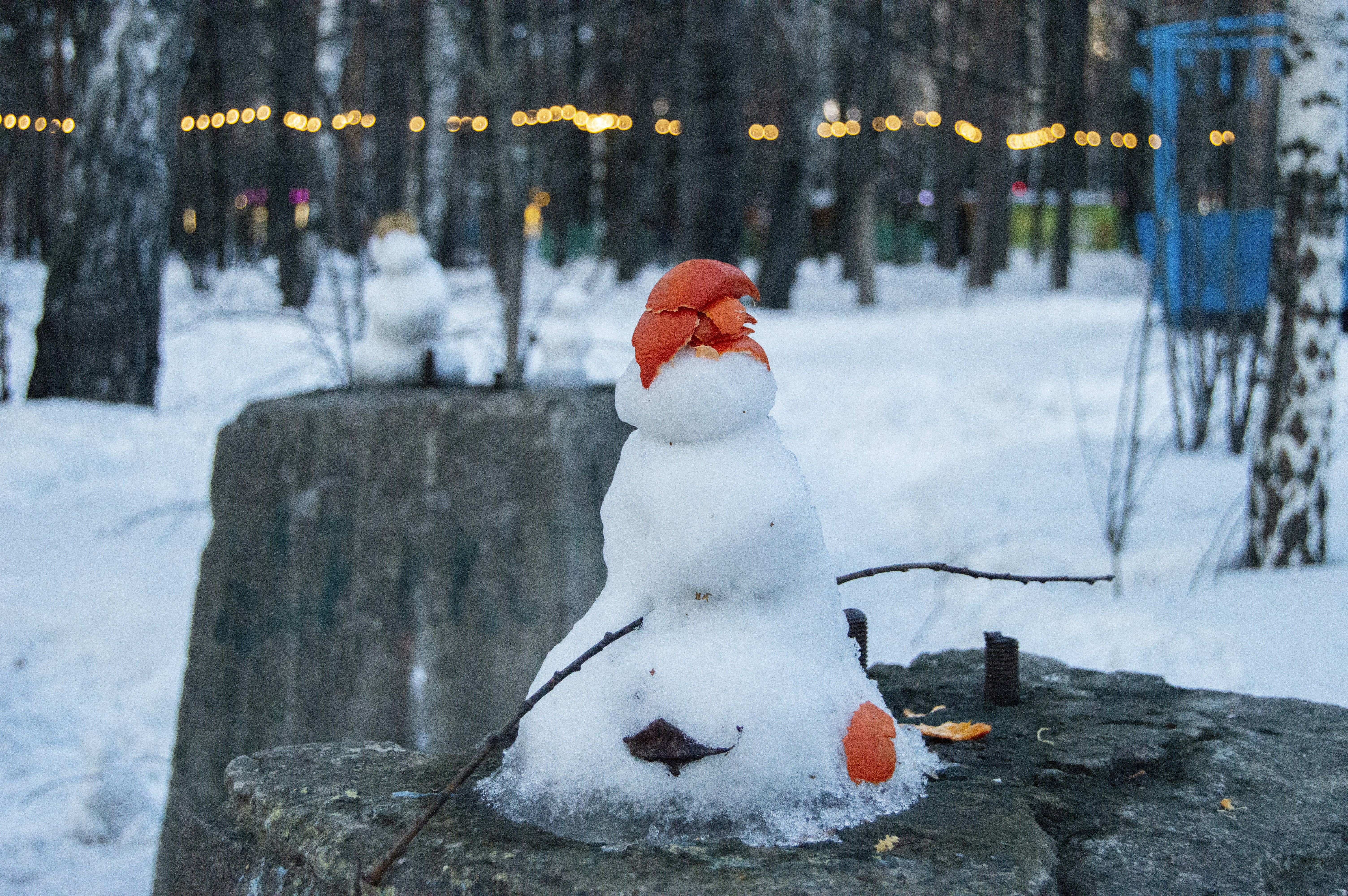 Snowbound Sentinel: A Tiny Snowman Guarding the Park's Frosty Edge