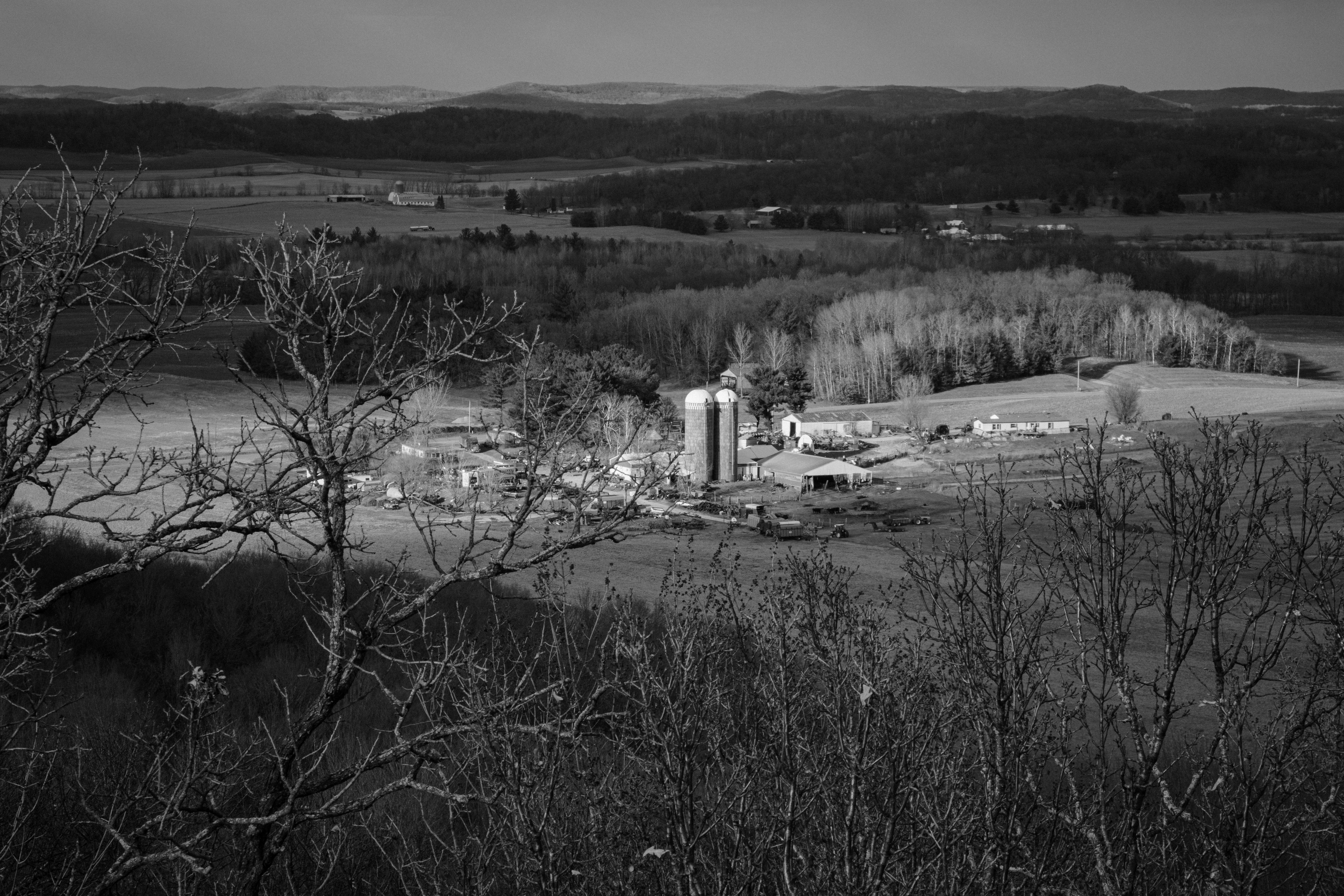 Silos in Silence: A Monochrome Farmstead Across the Valley