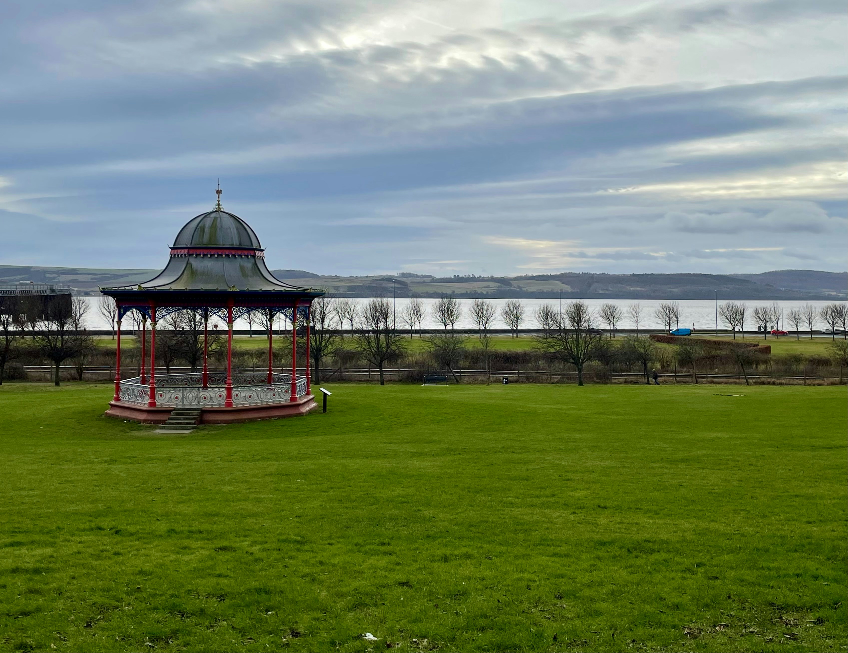 Gazebo set in a lush green field with the River Tay and distant hills in the background.