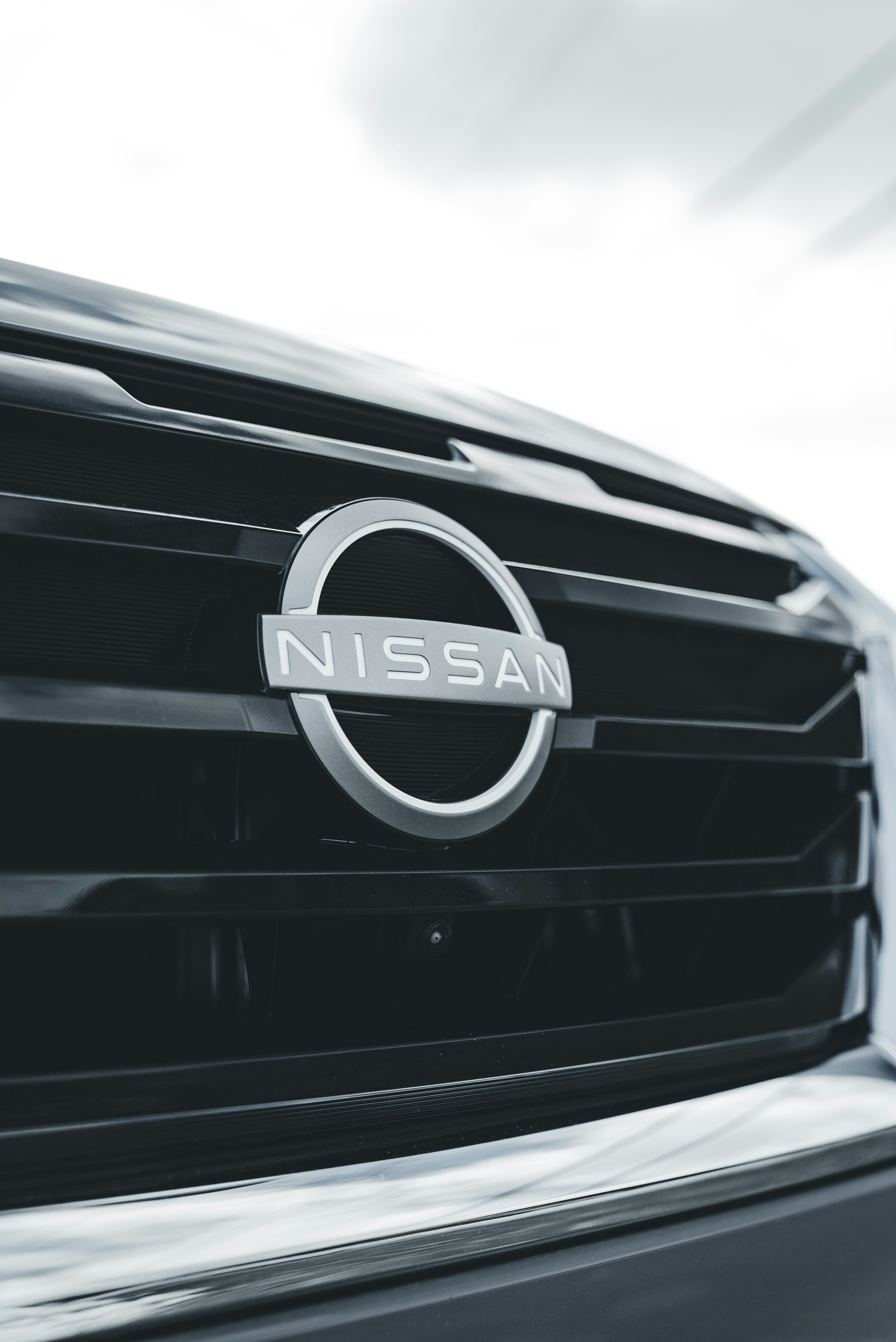 A close up of a nissan logo on a car photo – Free Logo Image on Unsplash
