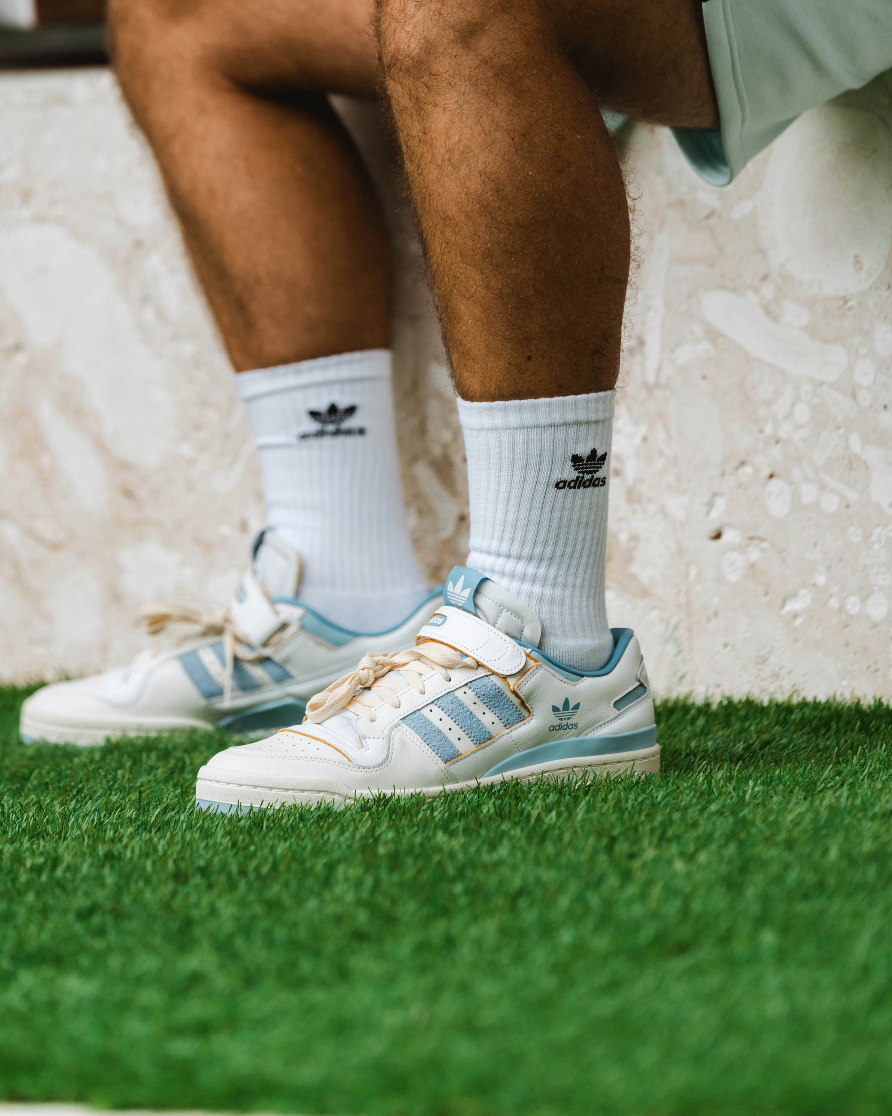 A close up of a person's legs wearing adidas sneakers photo – Free ...