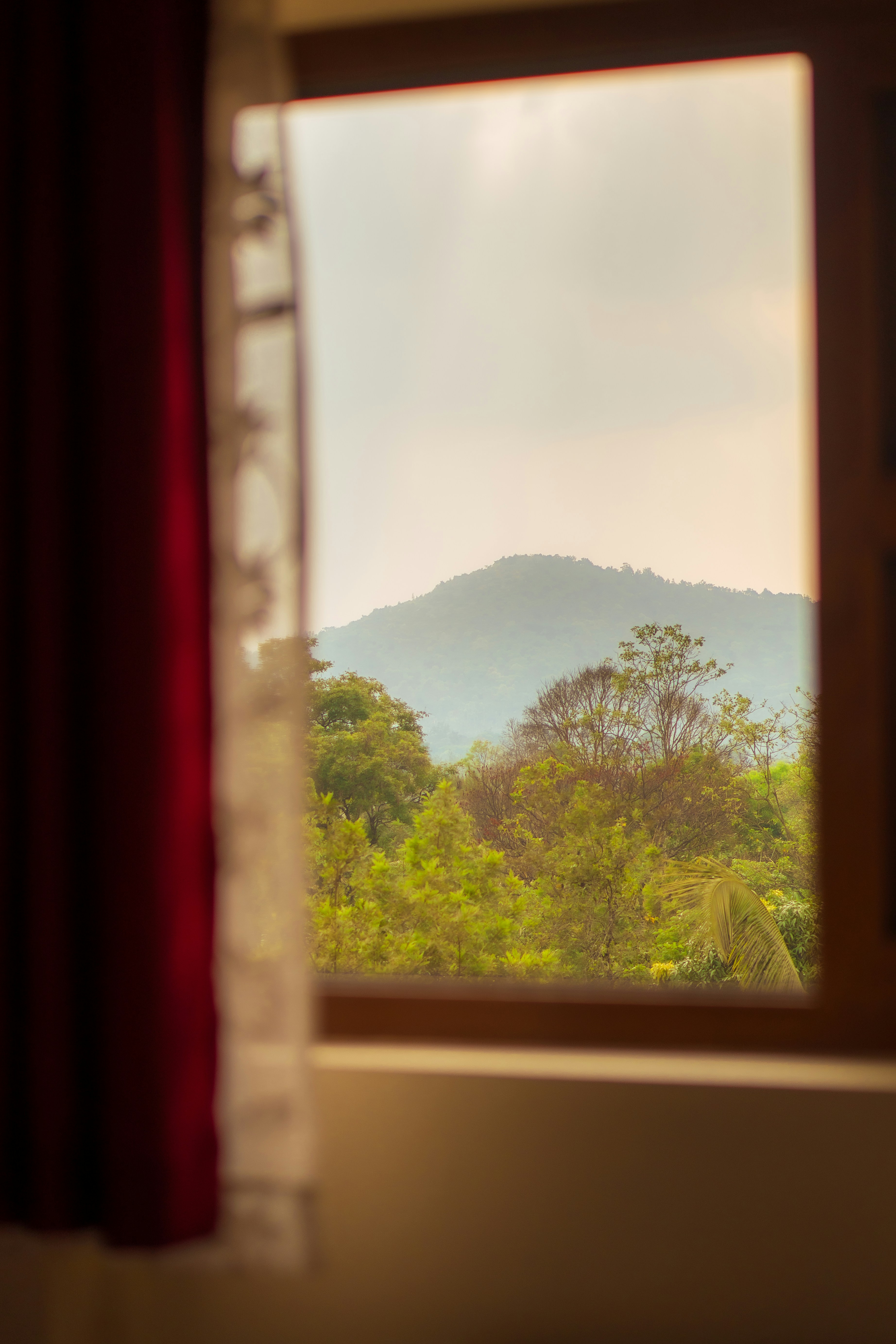 A view of a mountain from a window photo – Free Coorg Image on Unsplash
