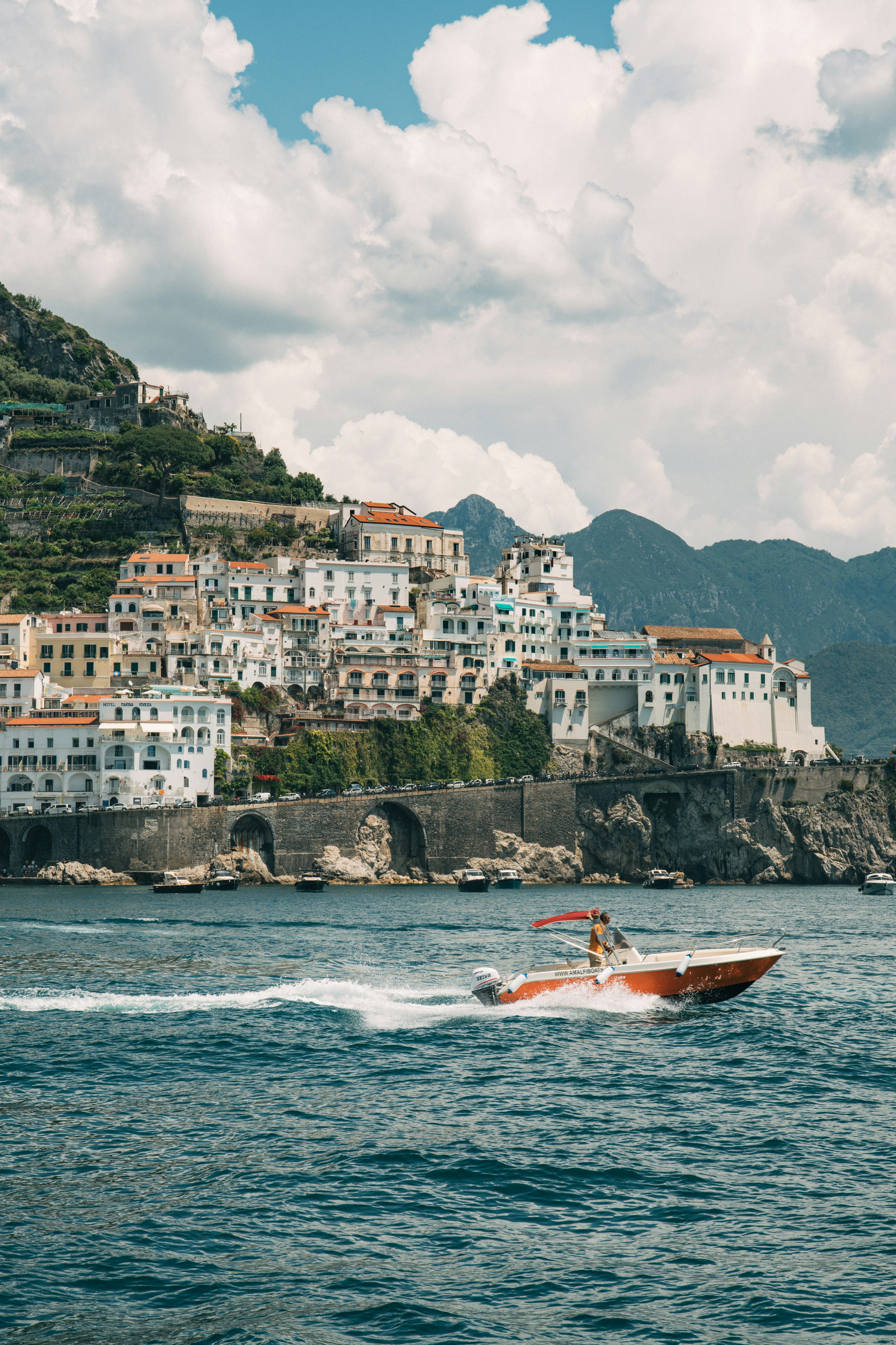 As the tour boat slowly comes into the harbor, there's a perfect view of boats leaving for the ocean in front of the coast.