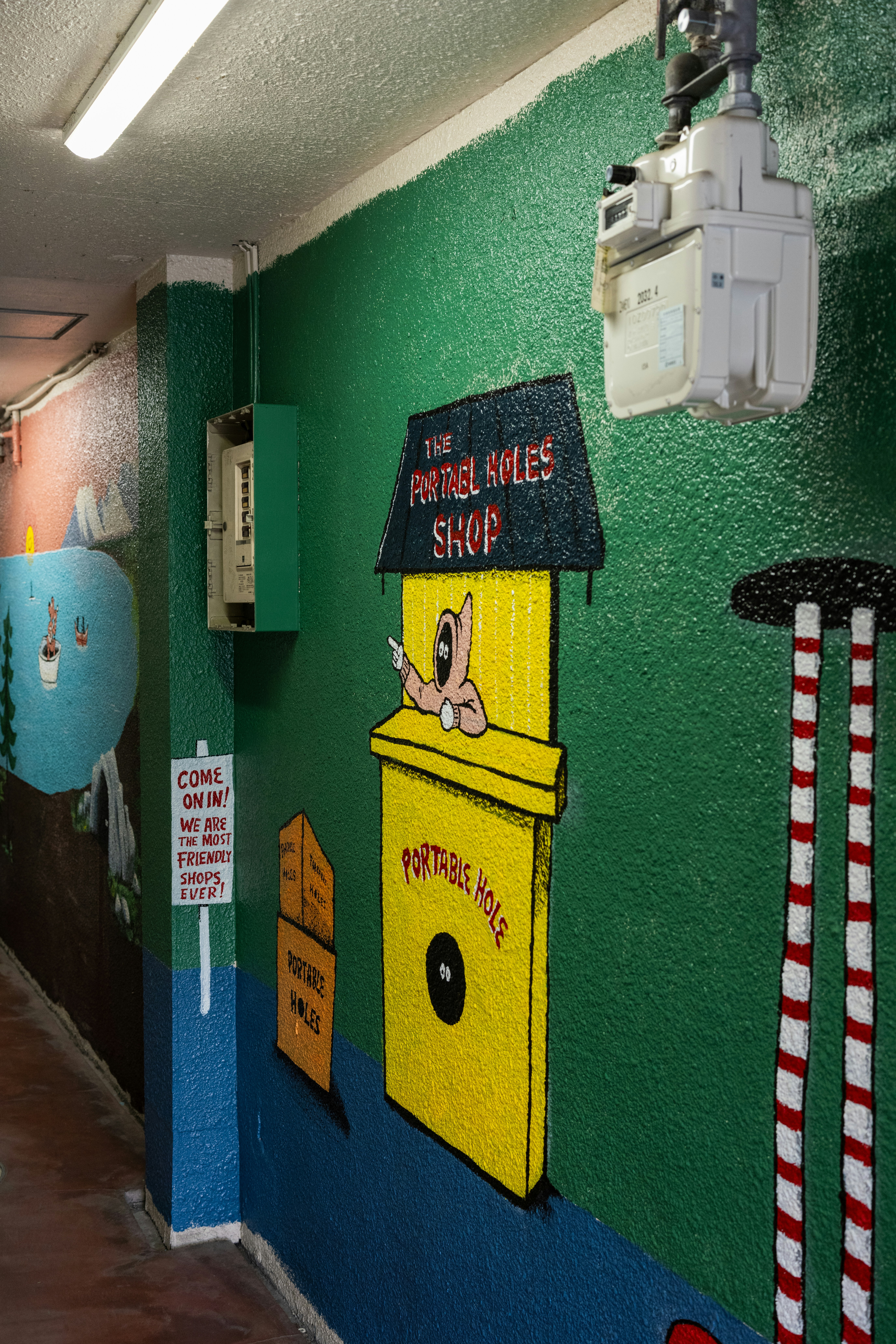 The Portable Hole mural: A bright yellow portal anchors a whimsical hallway scene
